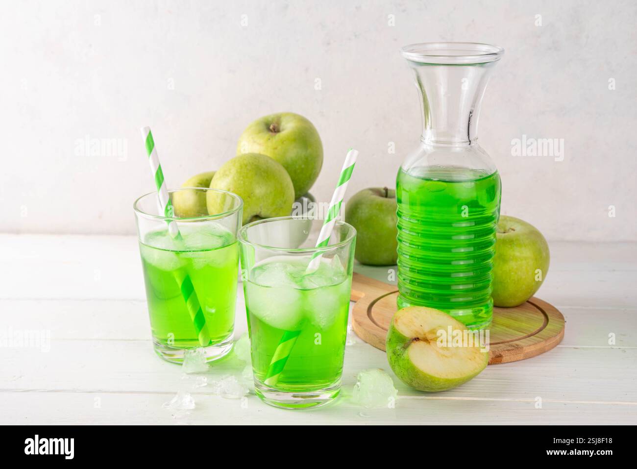 Homemade green apple lemonade cocktail, refreshing summer emerald color drink with fresh green ...