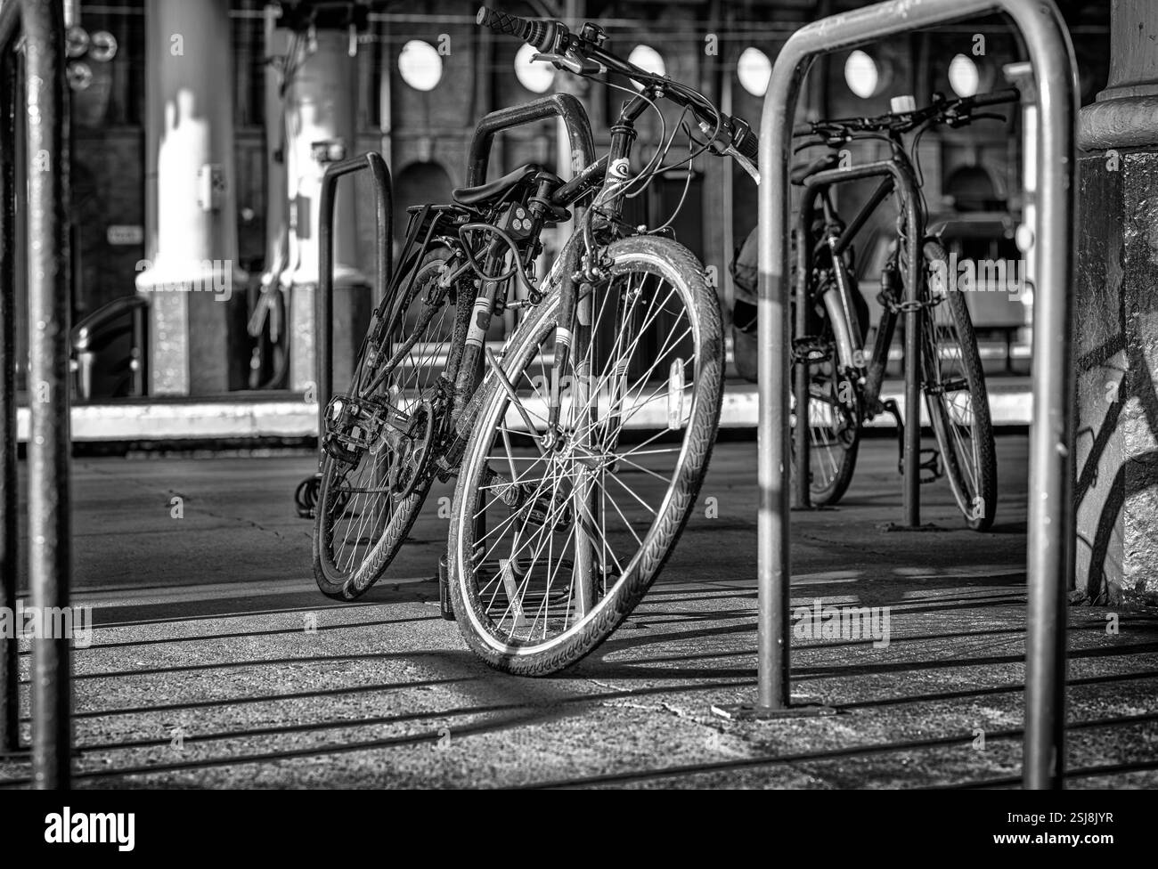 A bicycle is is standing on a railway platform fastened to a stanchion ...