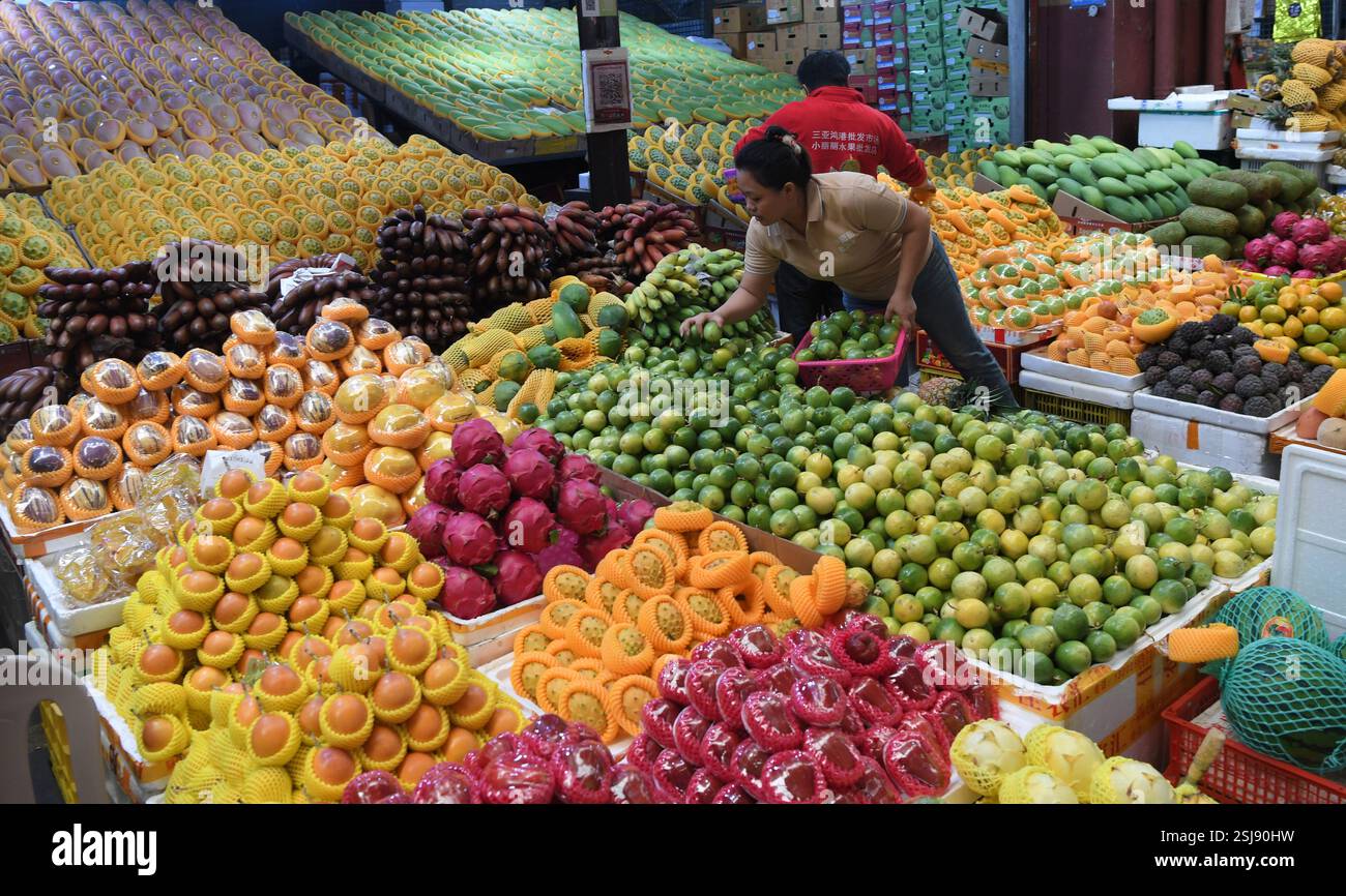 Sanya, China's Hainan Province. 11th Feb, 2025. Vendors arrange fruits ...