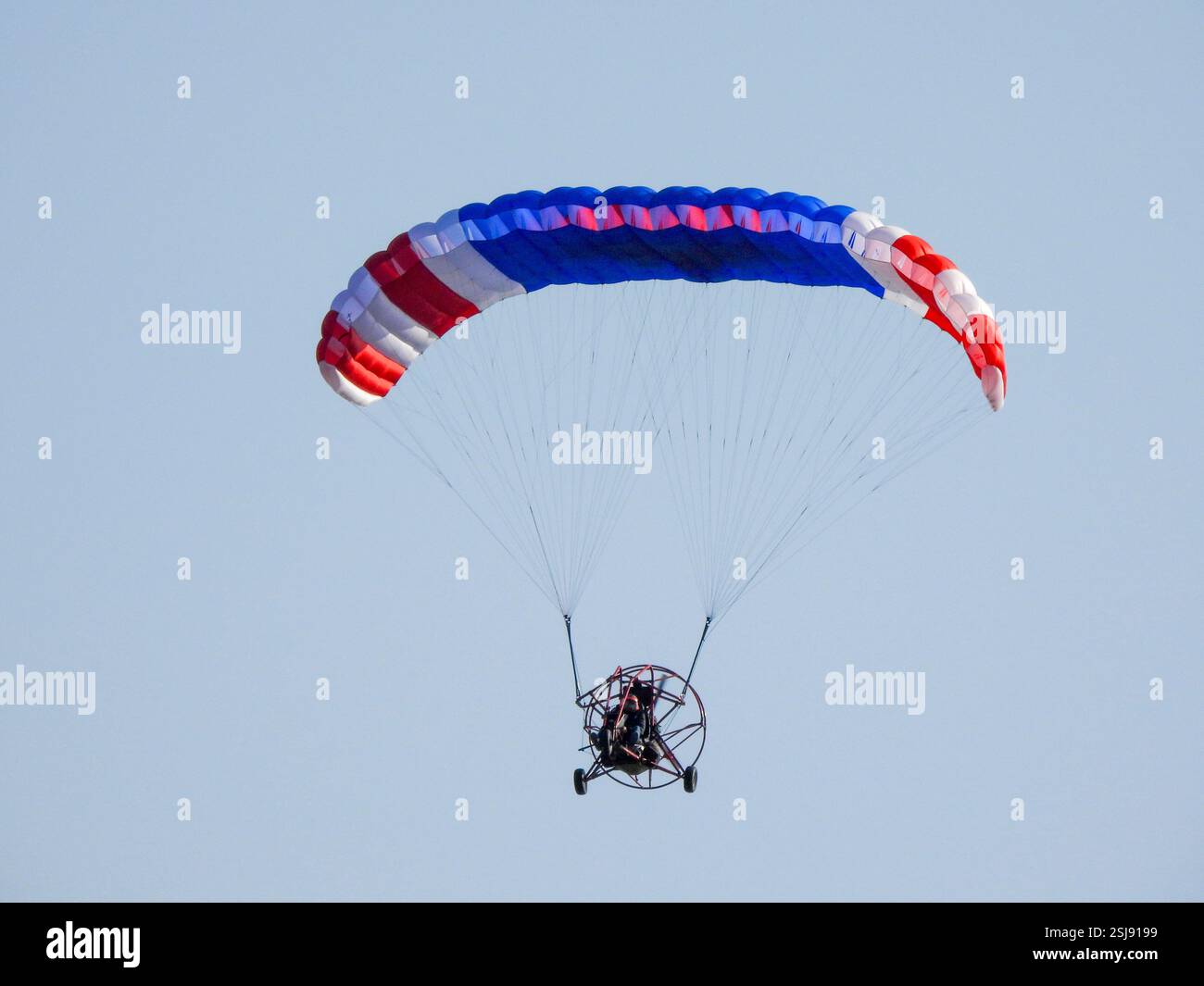 Paragliding with a blue sky background Stock Photo - Alamy