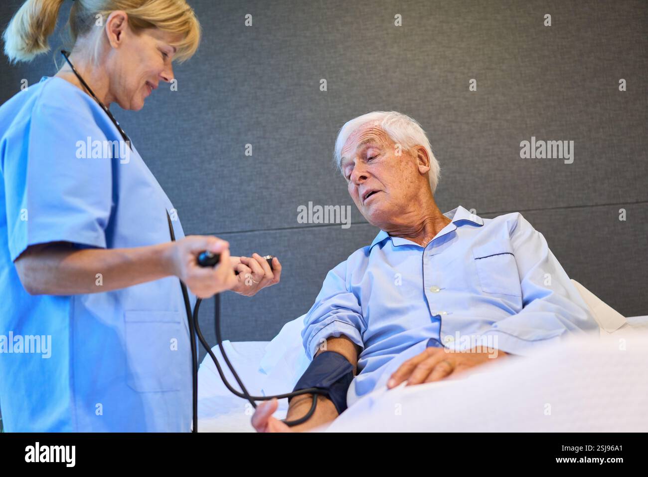An elderly man receiving attentive medical care as a healthcare ...