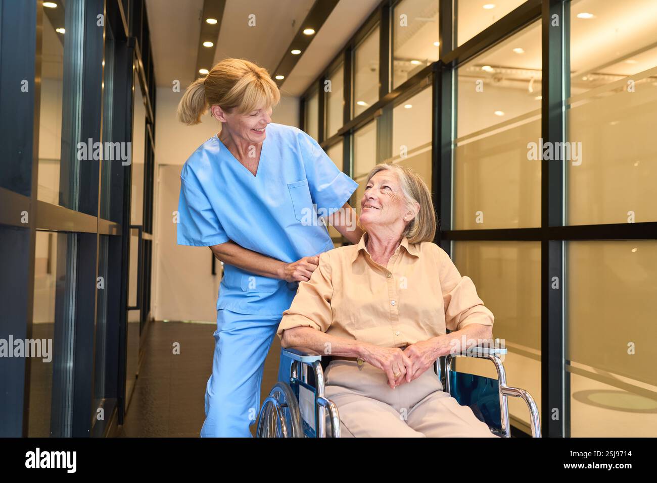 Doctor helps woman in wheelchair hi-res stock photography and images ...