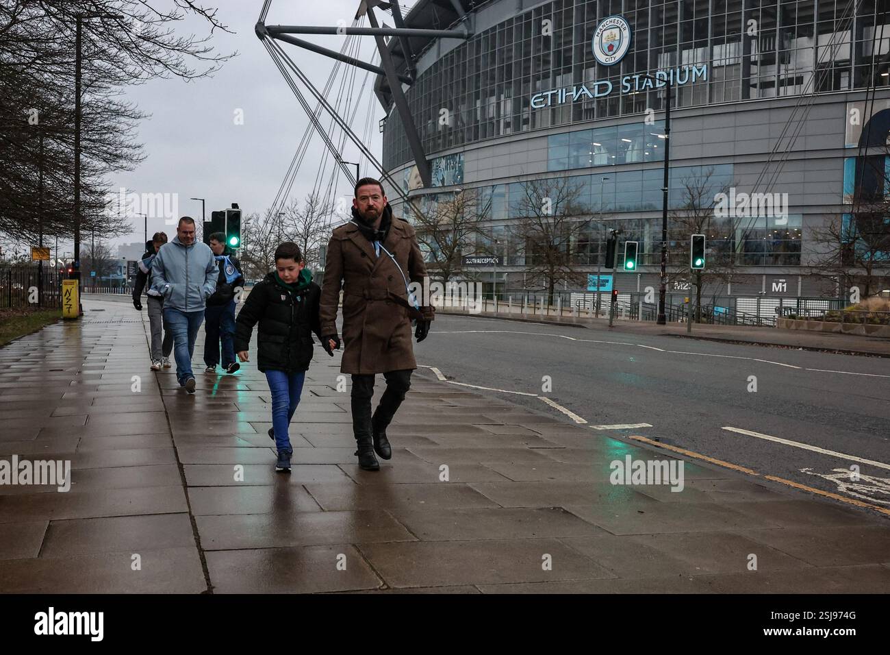 Fans walk in the locality of the Etihad Stadium during the UEFA ...