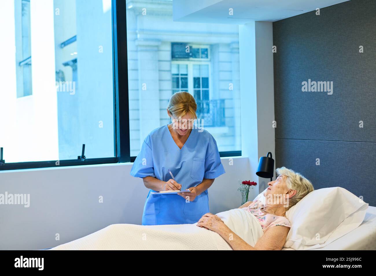 Nurse providing care and support to an elderly patient in a healthcare setting, promoting well ...