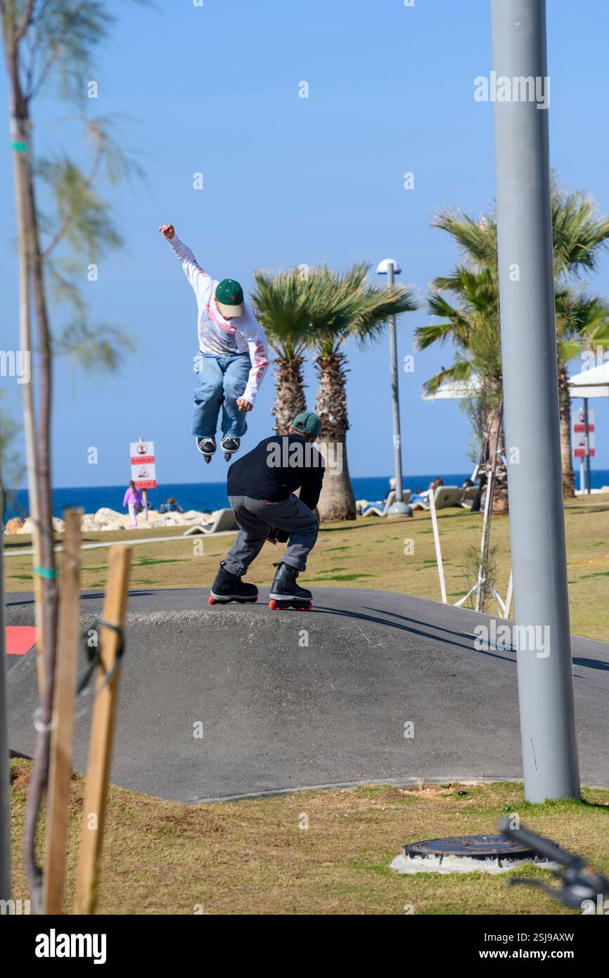 Urban extreme sport park. Young skateboarder performs stunts with a ...