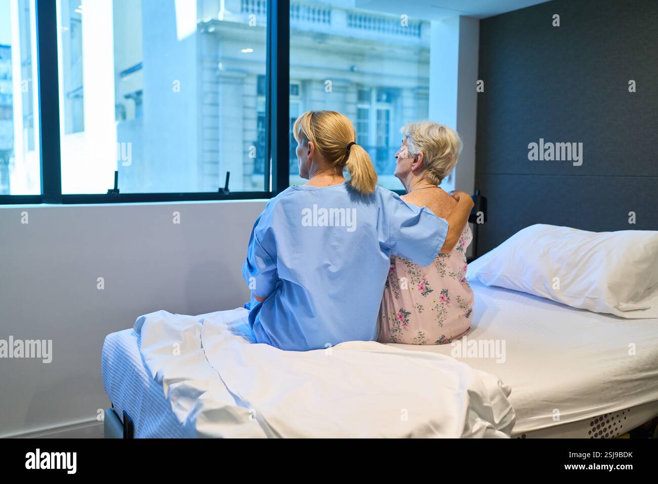 Compassionate nurse and senior patient share a caring moment in a ...