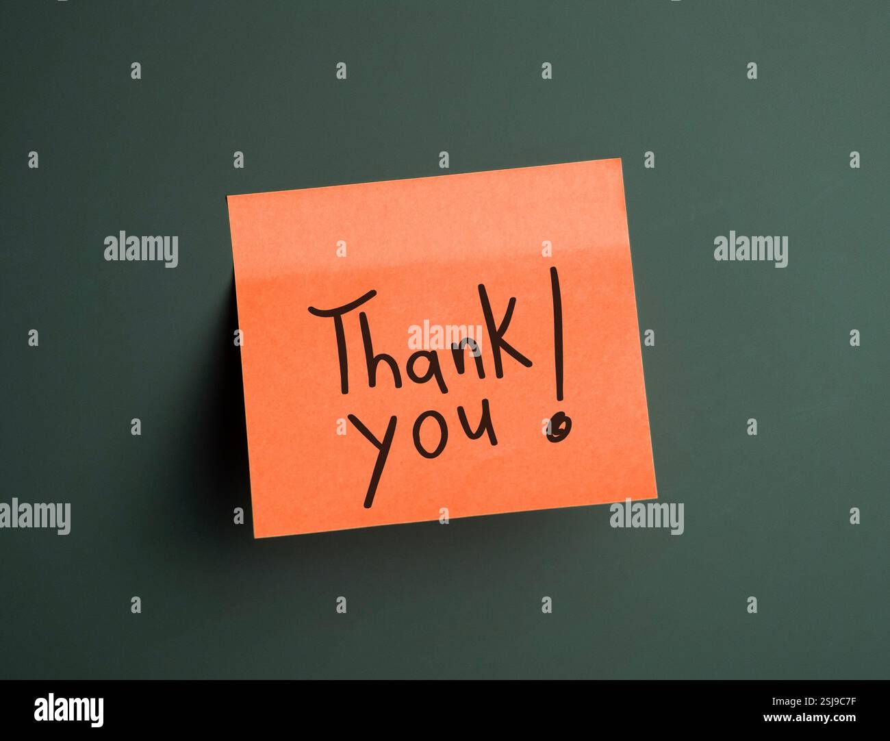 Bright orange sticky note with a handwritten thank you message on a ...