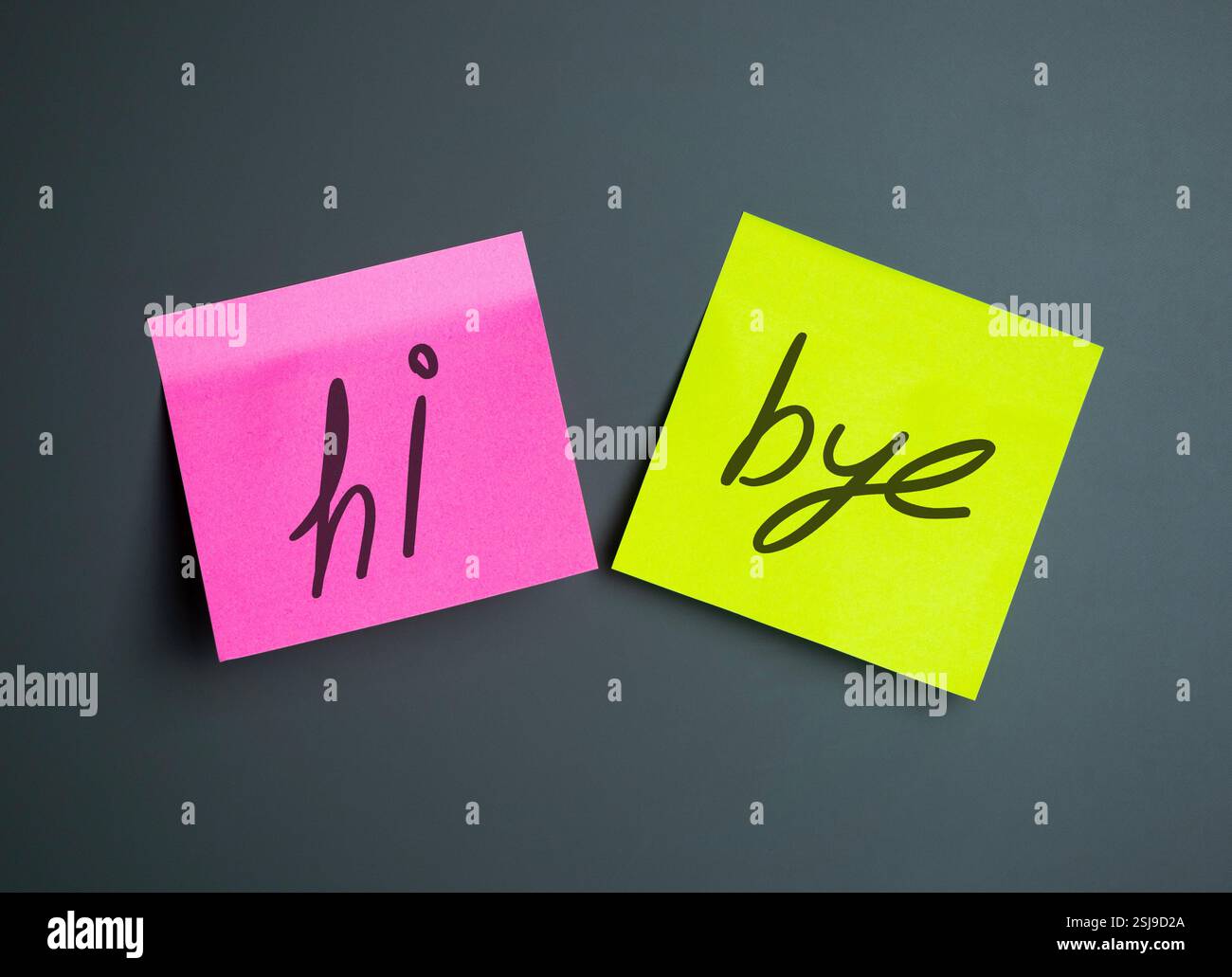 Two colorful sticky notes display the words hi and bye in cursive ...
