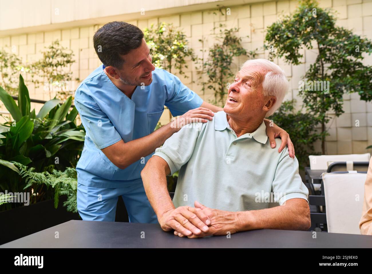 Compassionate caregiver engages hi-res stock photography and images - Alamy