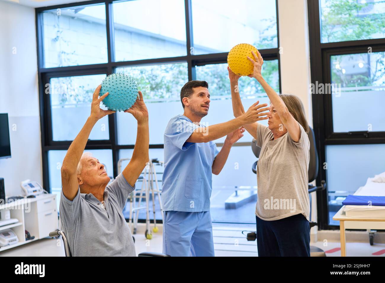 Seniors participate in rehabilitation exercises with colorful balls ...