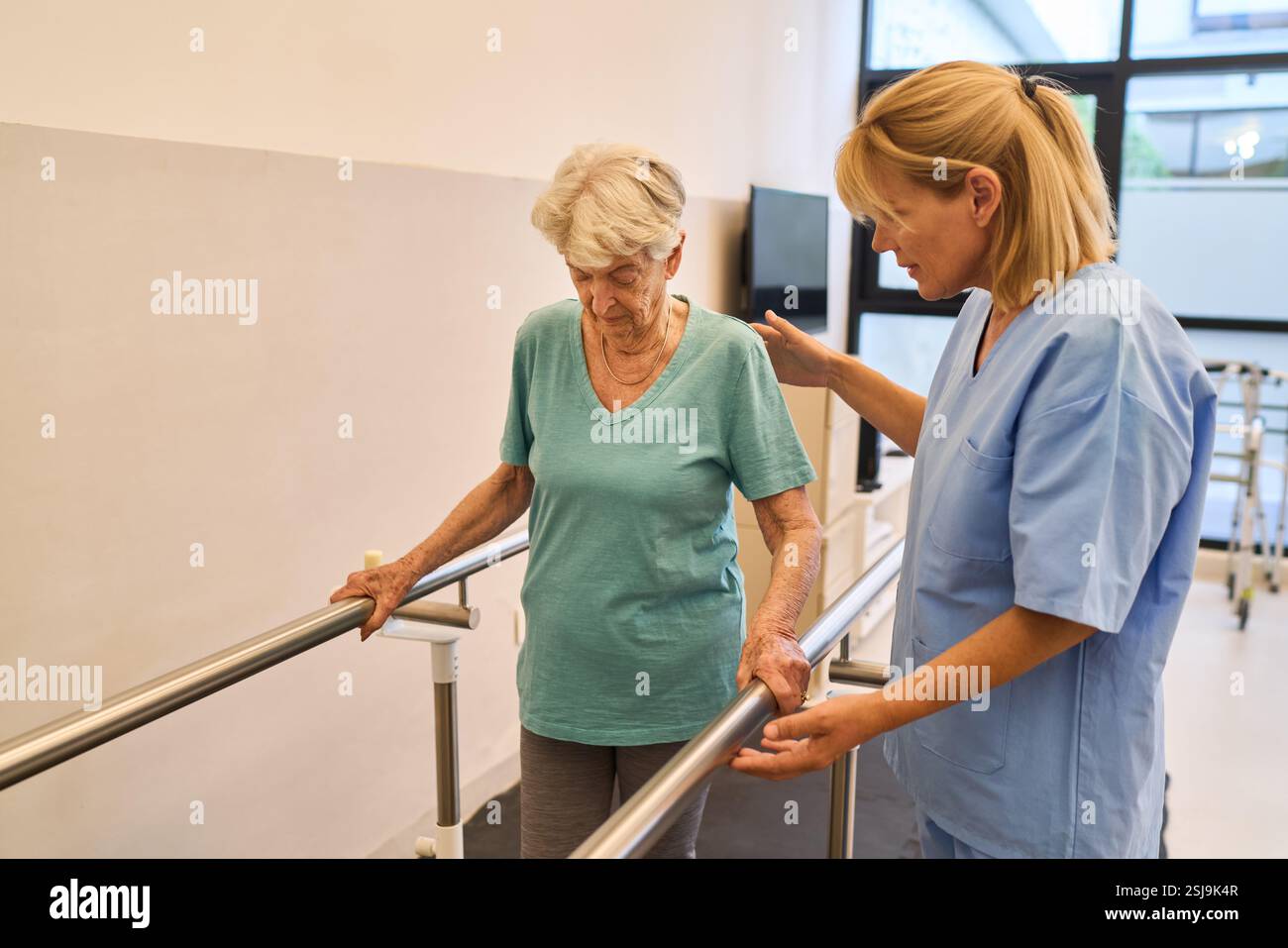 Senior female patient practicing rehabilitation exercises with the ...