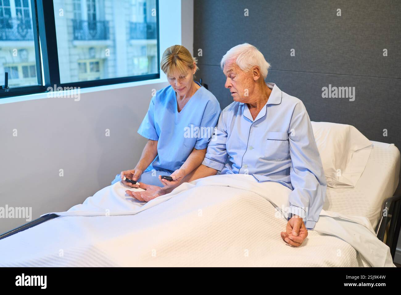 Caregiver elderly patient assists hi-res stock photography and images ...
