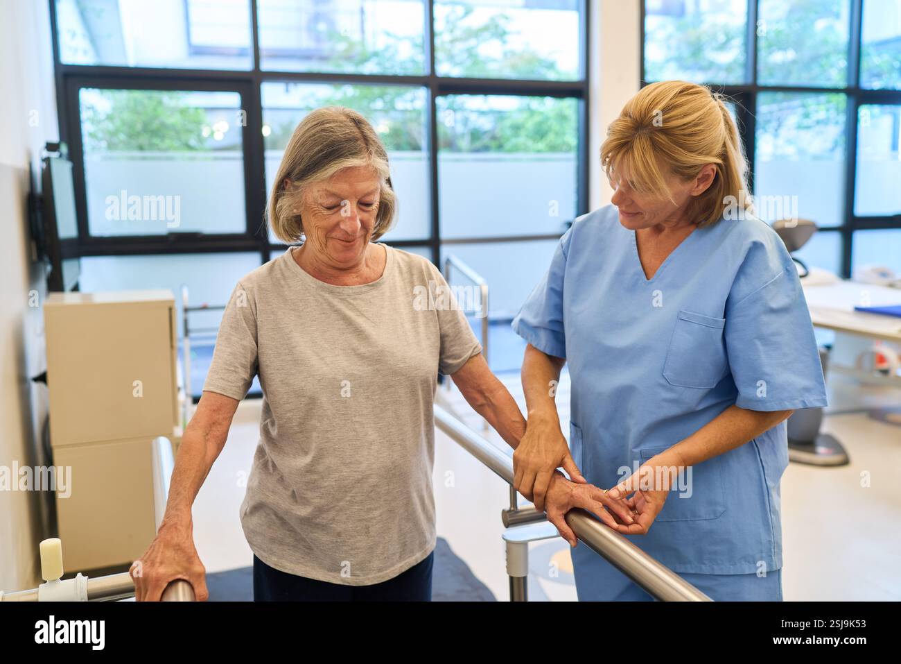 An elderly woman being assisted by a healthcare professional during a ...