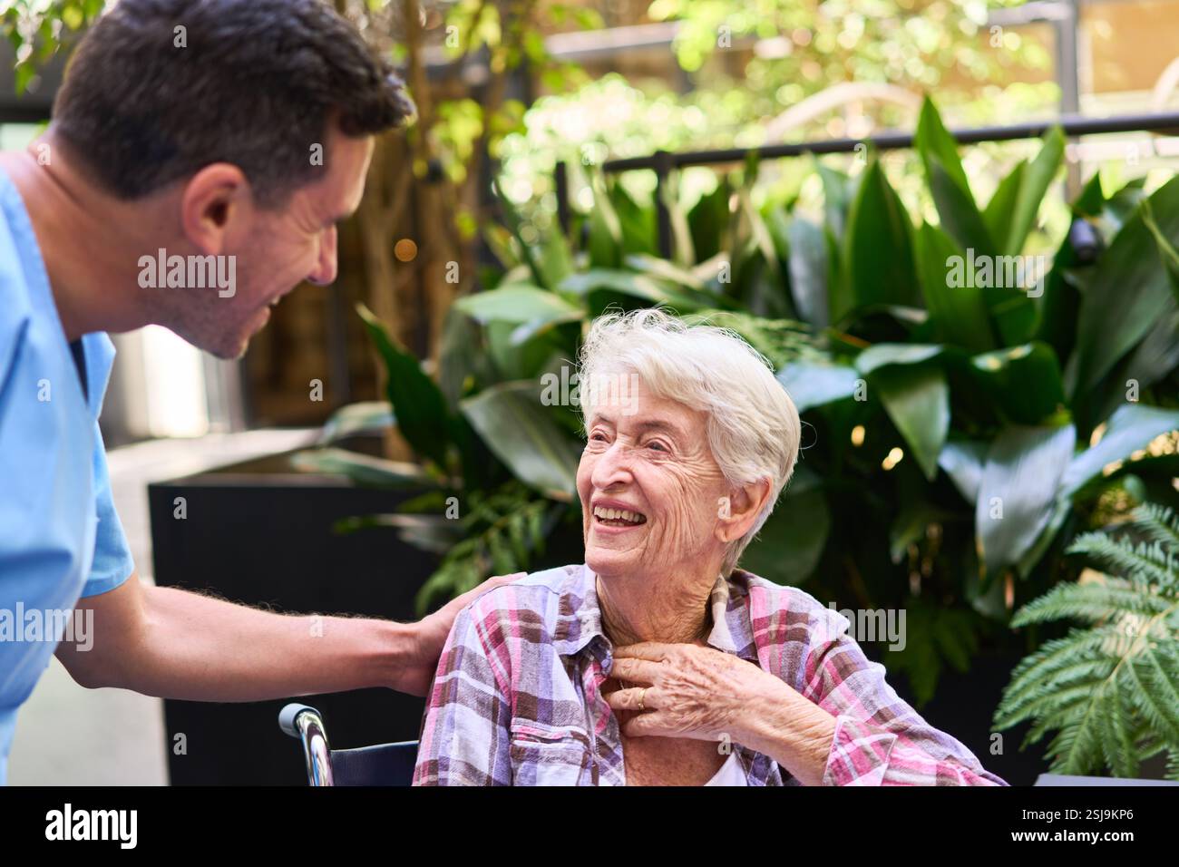 A caregiver warmly engages with a senior individual, emphasizing ...