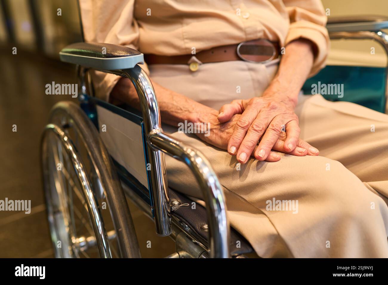 Close-up image of an elderly individual seated in a wheelchair ...