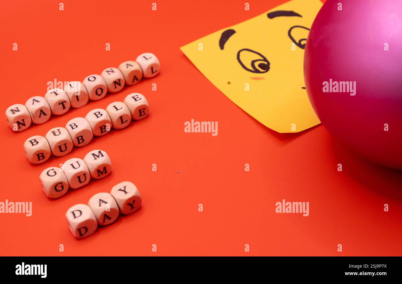 A concept of an emoticon note, blowing a bubble of bubble gum on a red ...