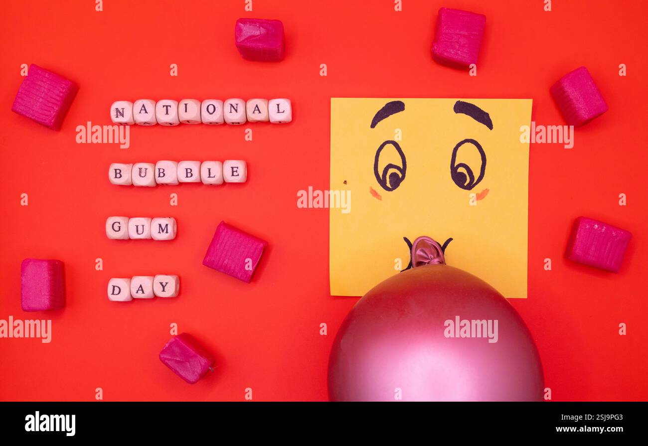 A concept of an emoticon note, blowing a bubble of bubble gum on a red ...