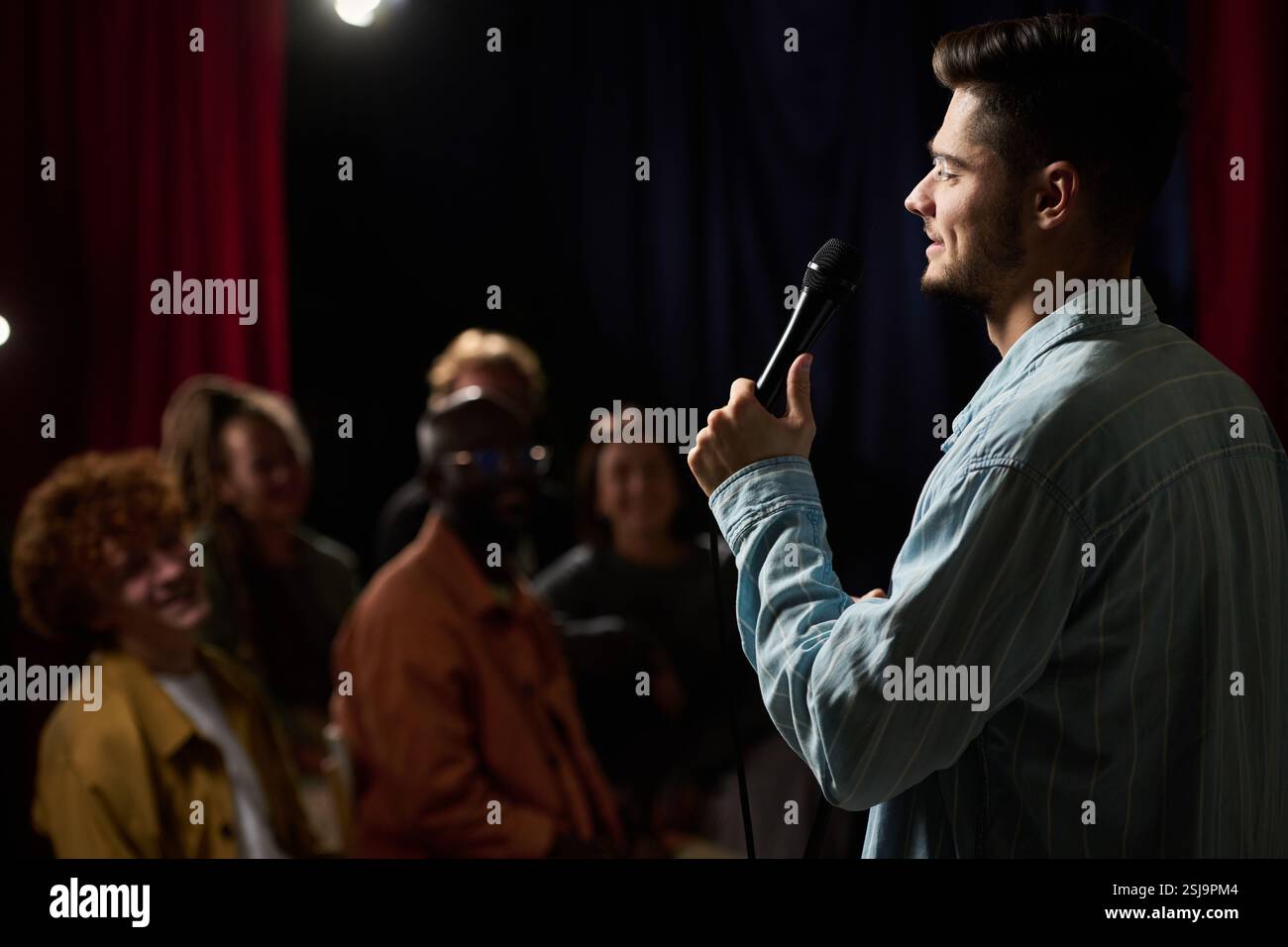 Comedian delivering his routine on stage, entertaining an engaged ...