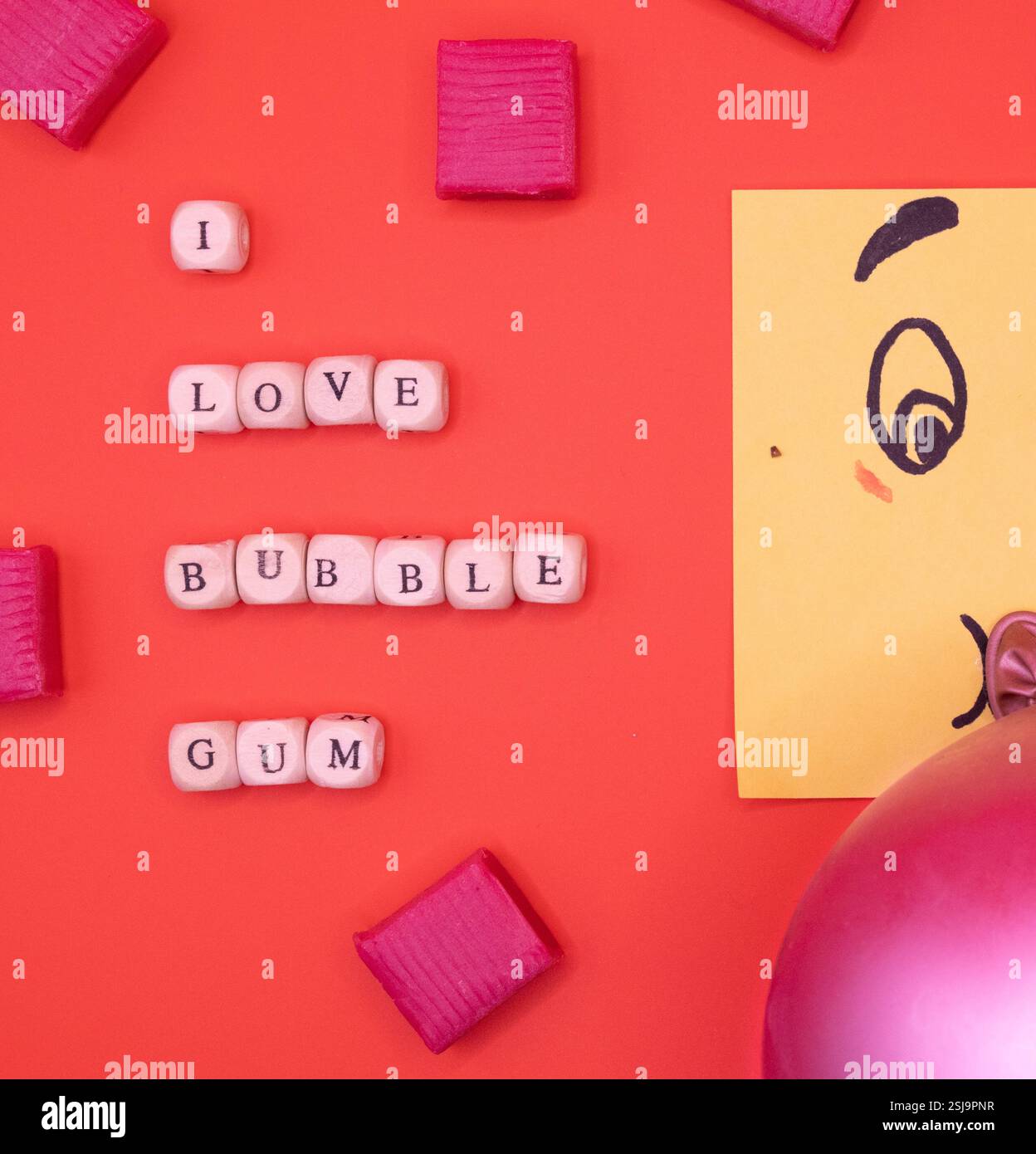 A concept of an emoticon note, blowing a bubble of bubble gum on a red ...