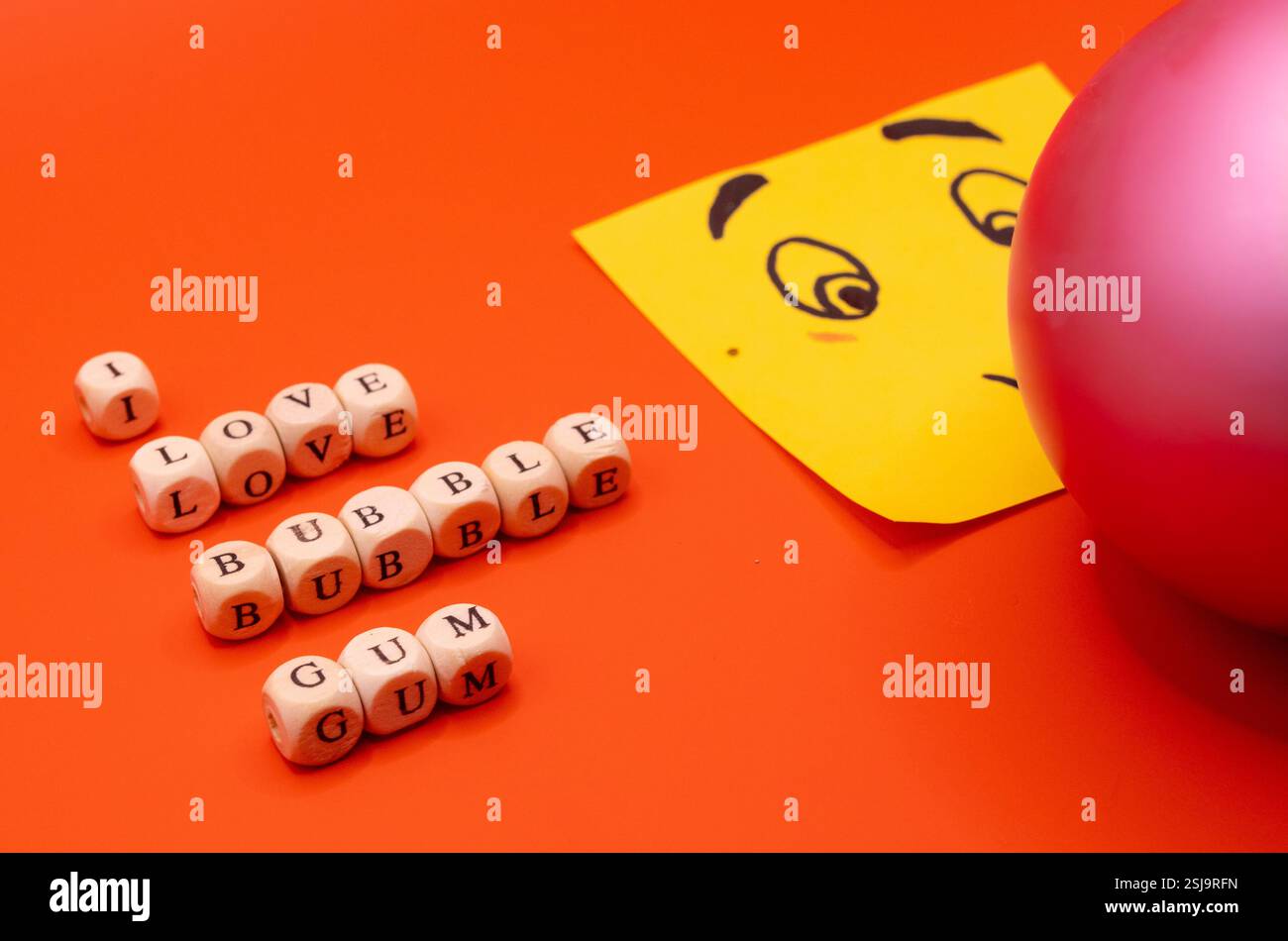 A concept of an emoticon note, blowing a bubble of bubble gum on a red ...