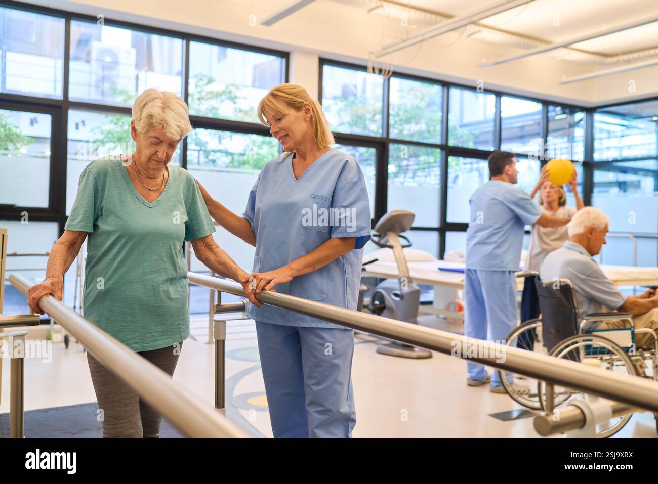 A senior woman assisted by a healthcare professional during a ...