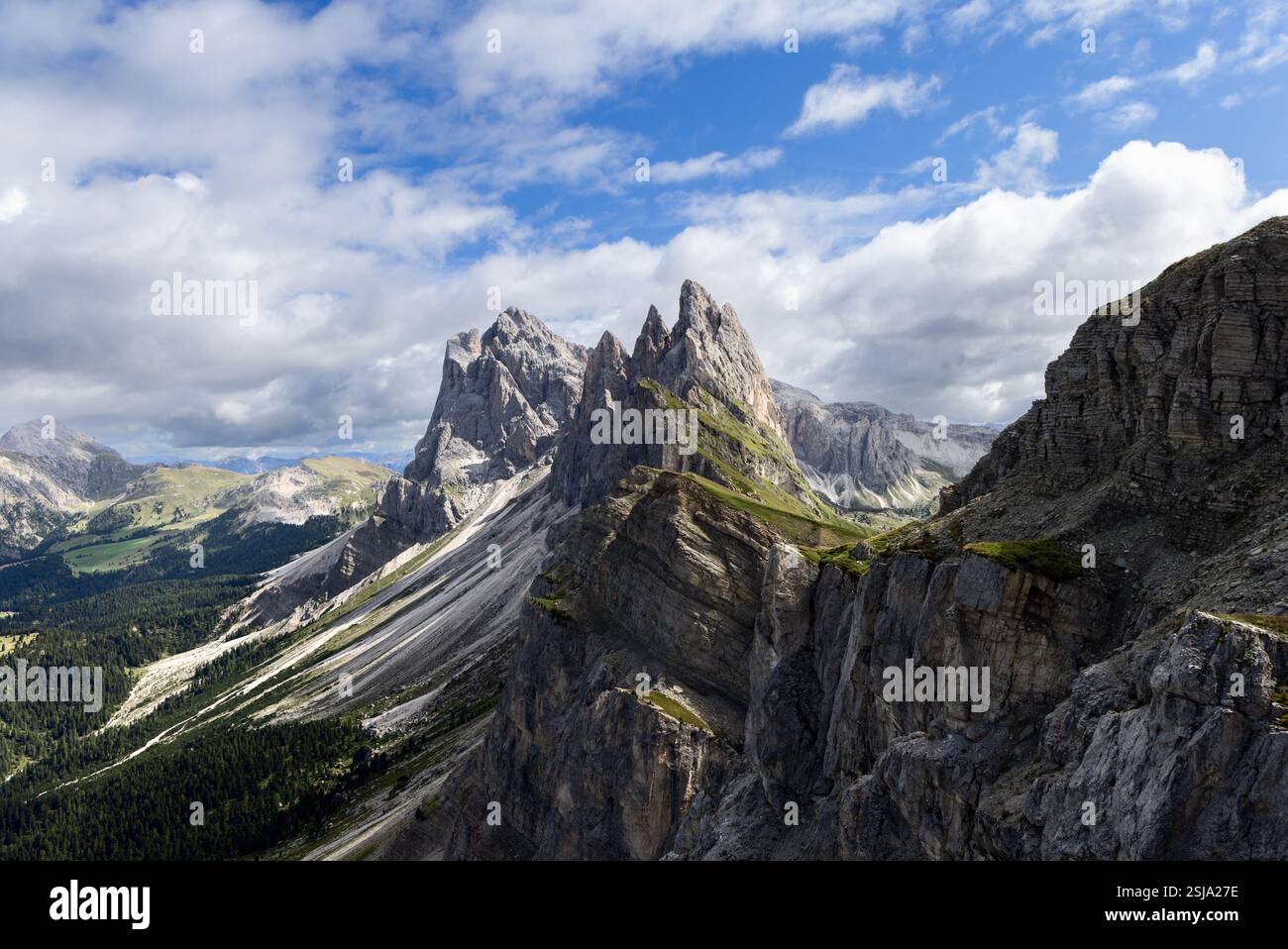 The iconic Seceda peaks rise dramatically from the plateau and meadows ...