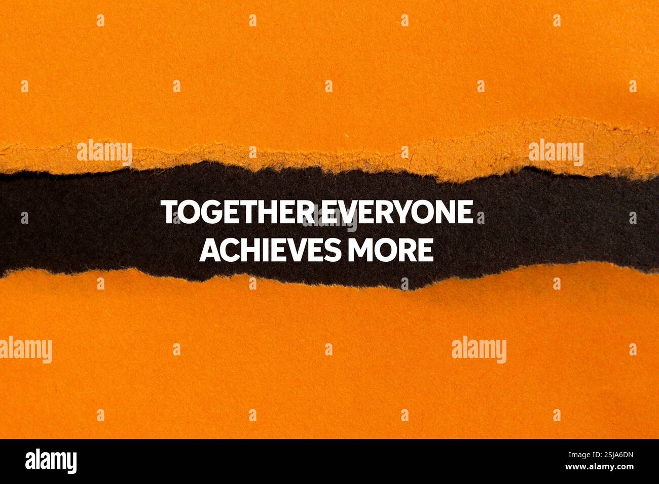 Together everyone achieves more message written on ripped torn orange ...