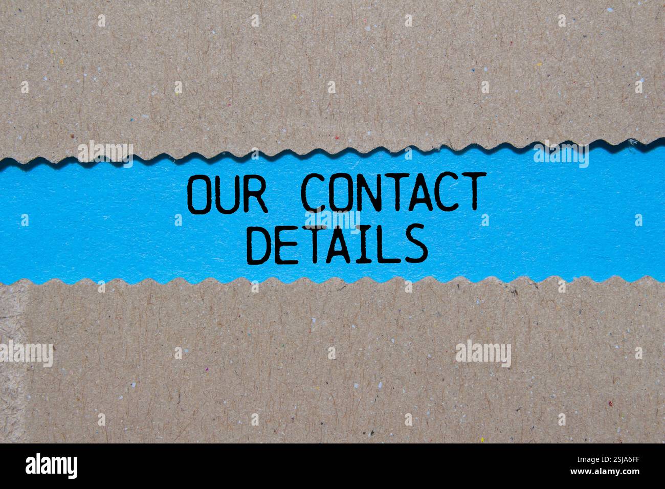 Our contact details message written on ripped torn paper on blue background. Conceptual our ...