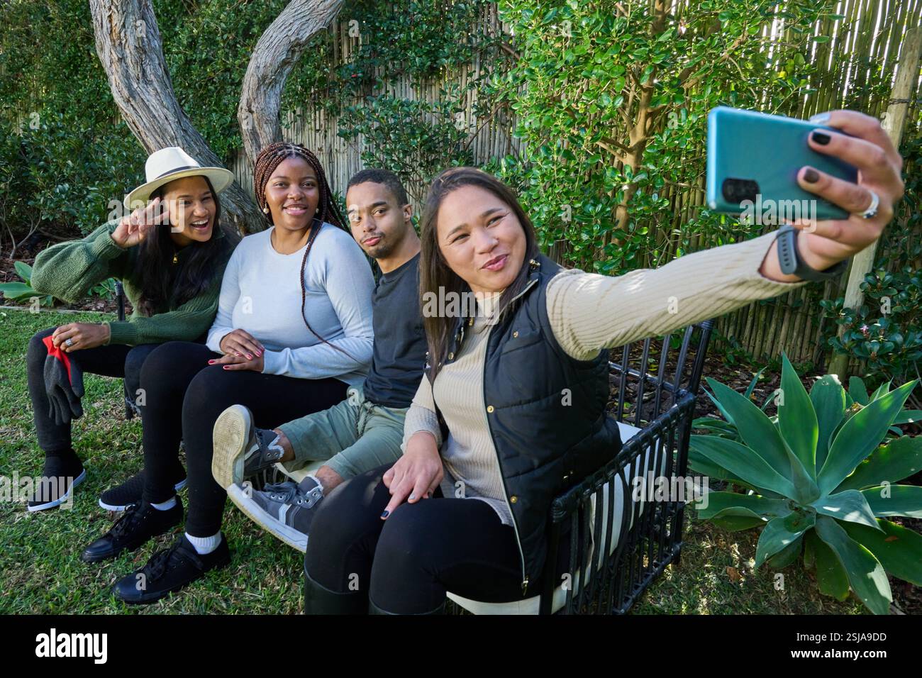 Friends taking selfie on bench Stock Photo - Alamy