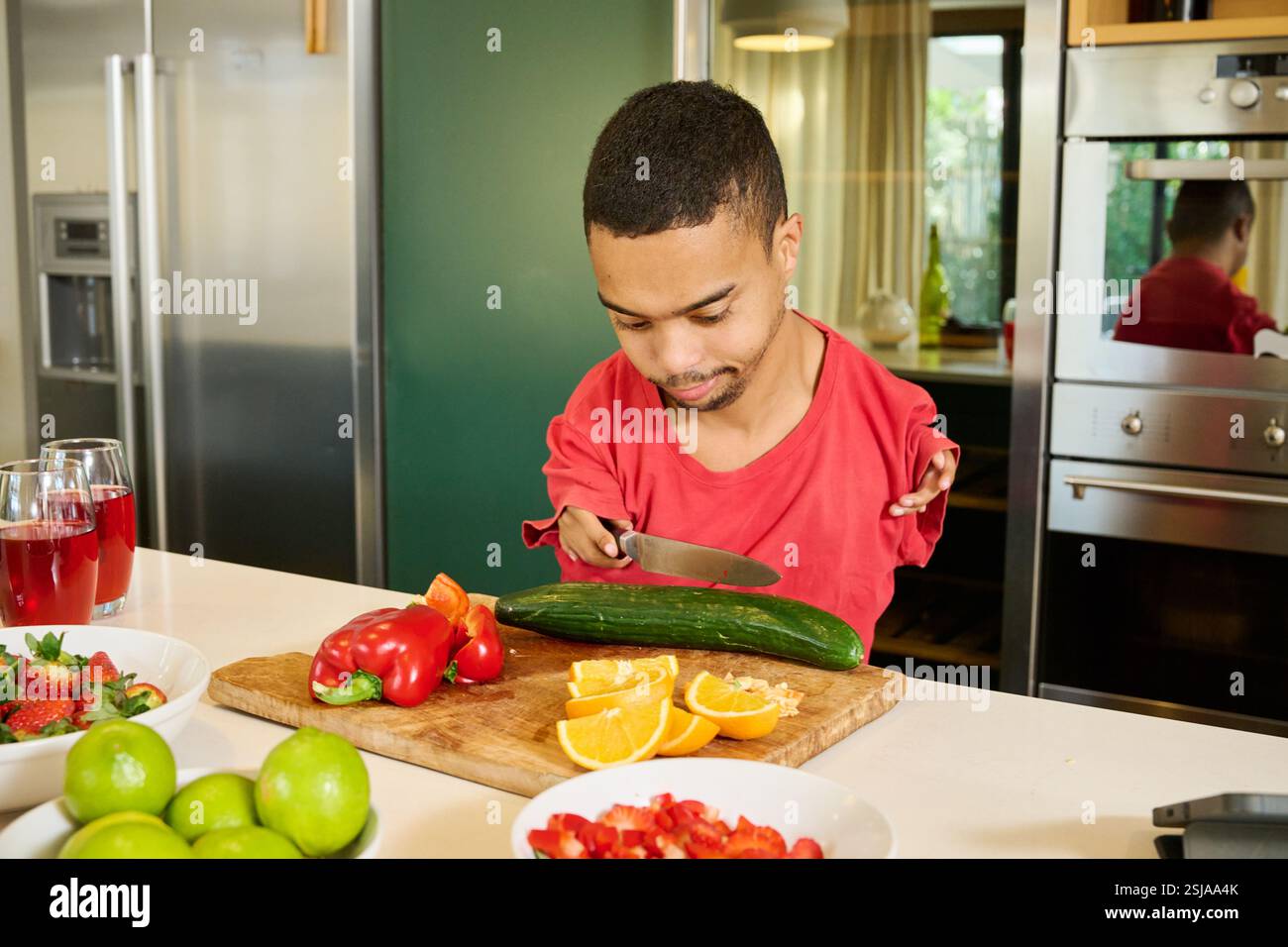 Man with phocomelia cutting vegetables Stock Photo - Alamy