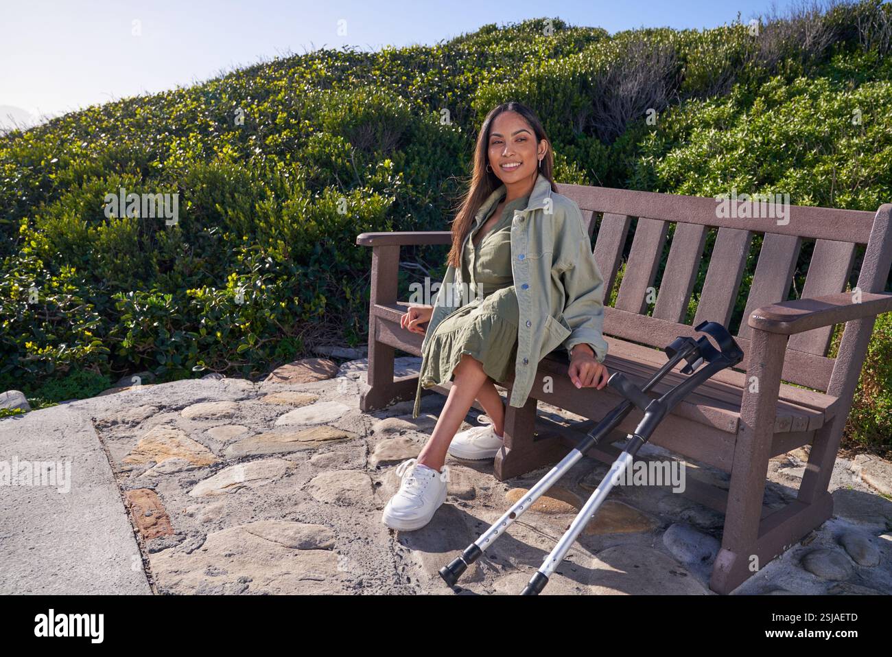 Disabled woman on bench in landscape Stock Photo - Alamy