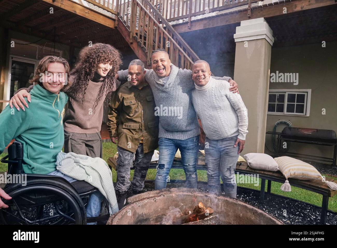 Disabled friends around fire pit Stock Photo - Alamy