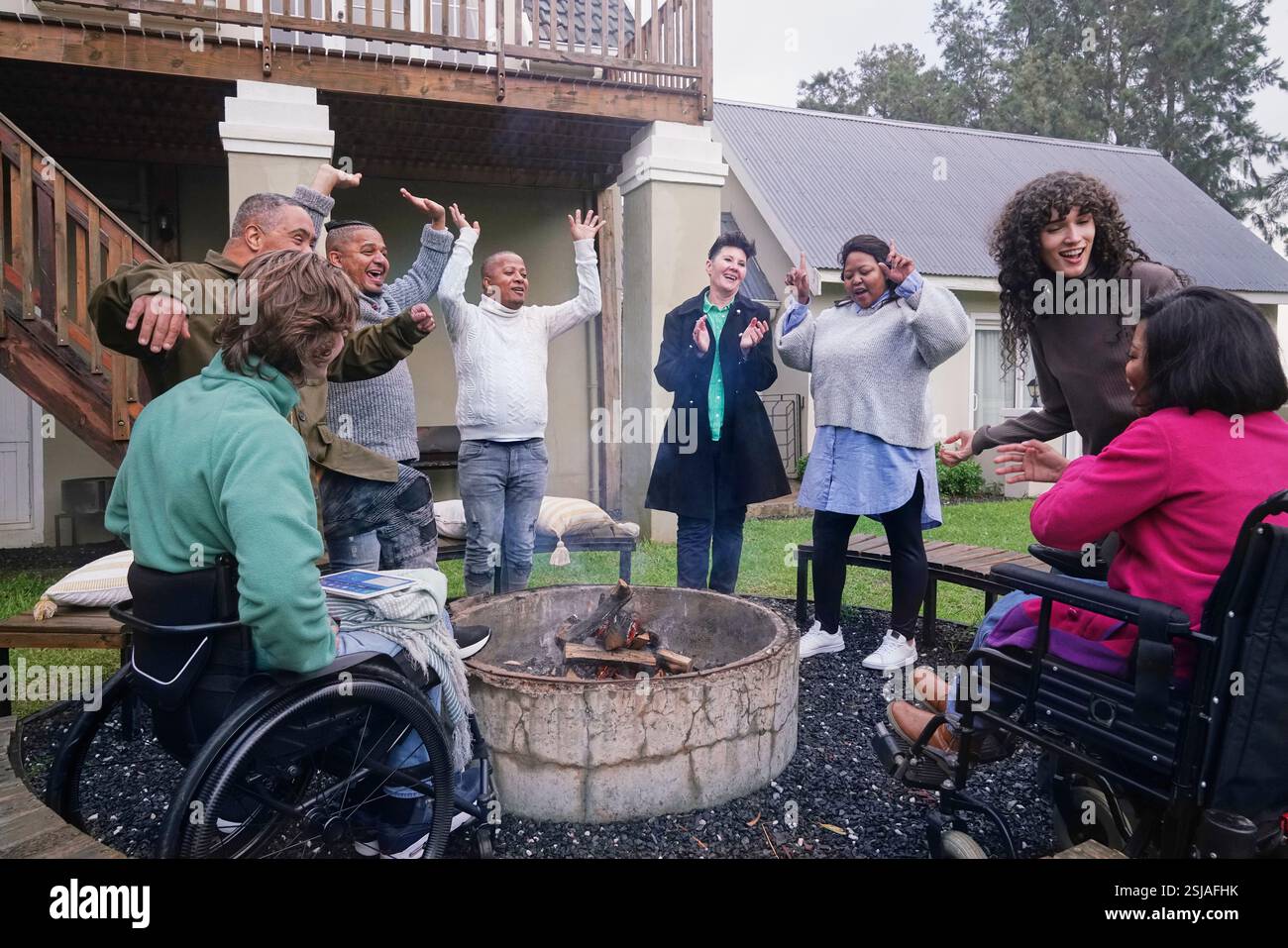 Disabled friends around fire pit Stock Photo - Alamy