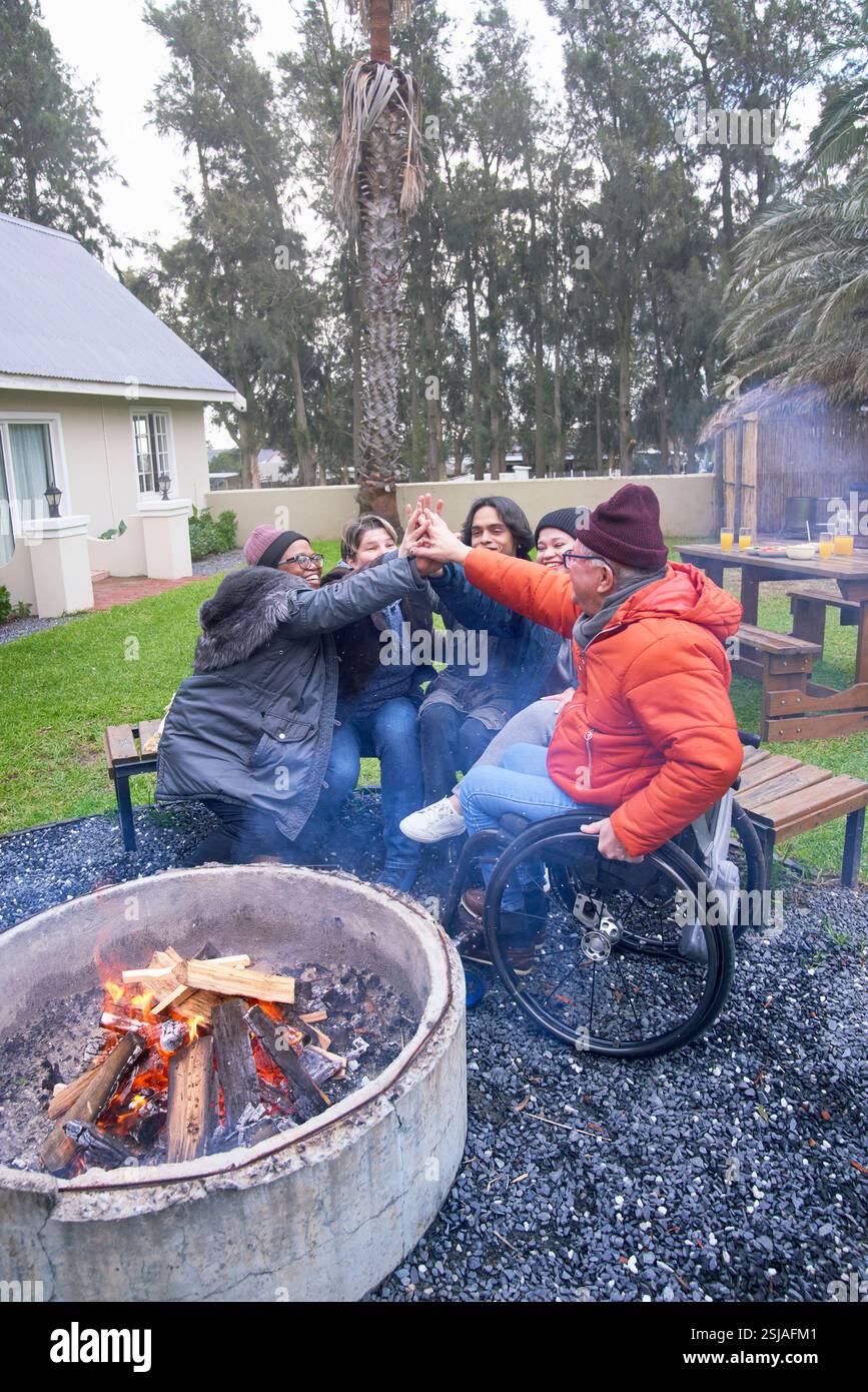 Friends around fire pit Stock Photo - Alamy