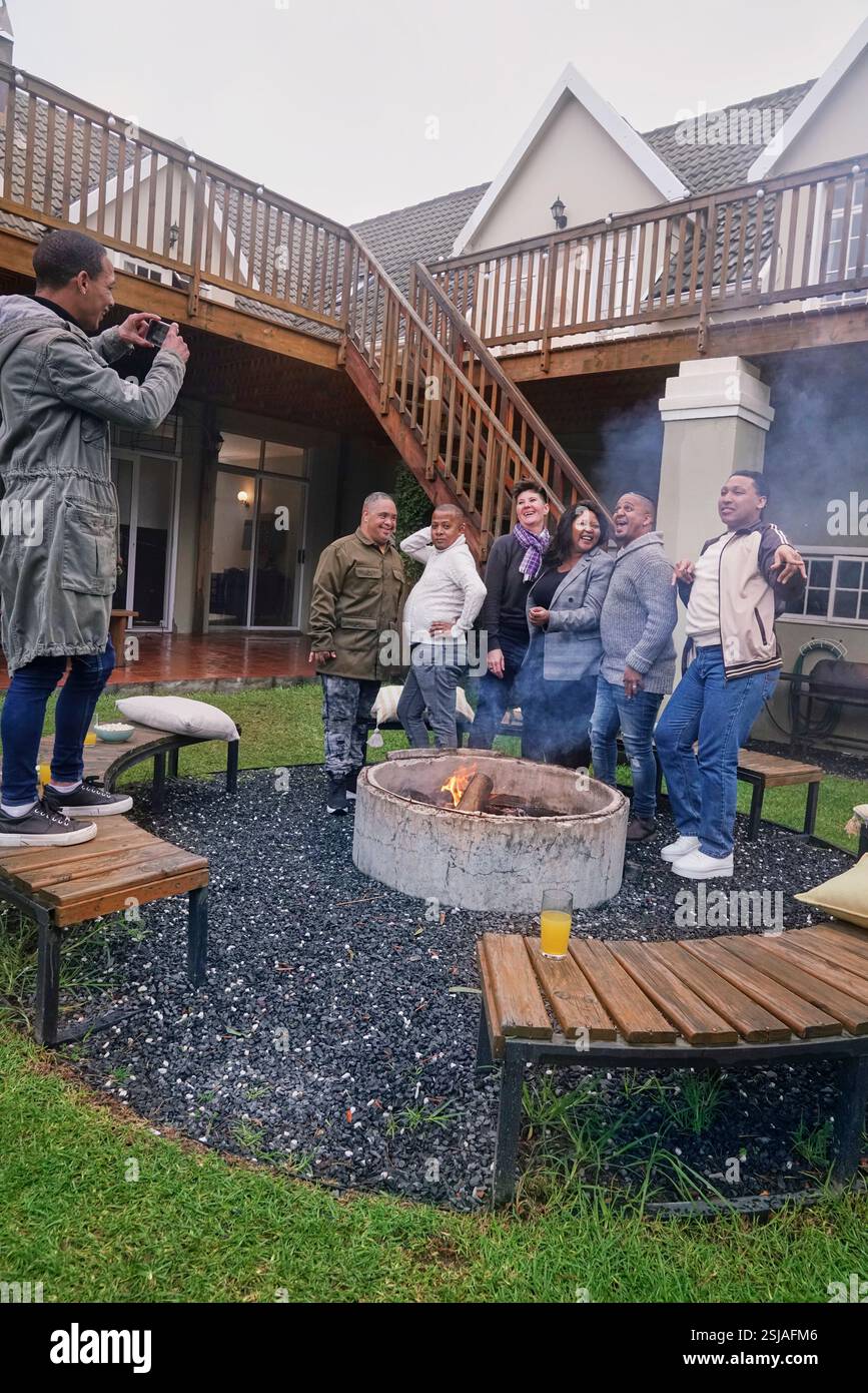 Friends around fire pit Stock Photo - Alamy
