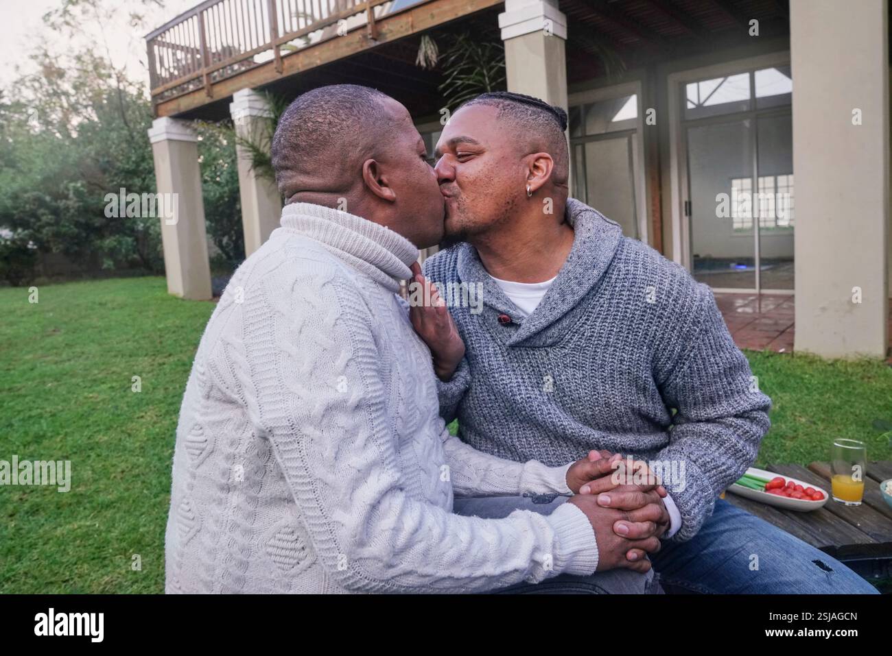 Gay couple kissing Stock Photo - Alamy