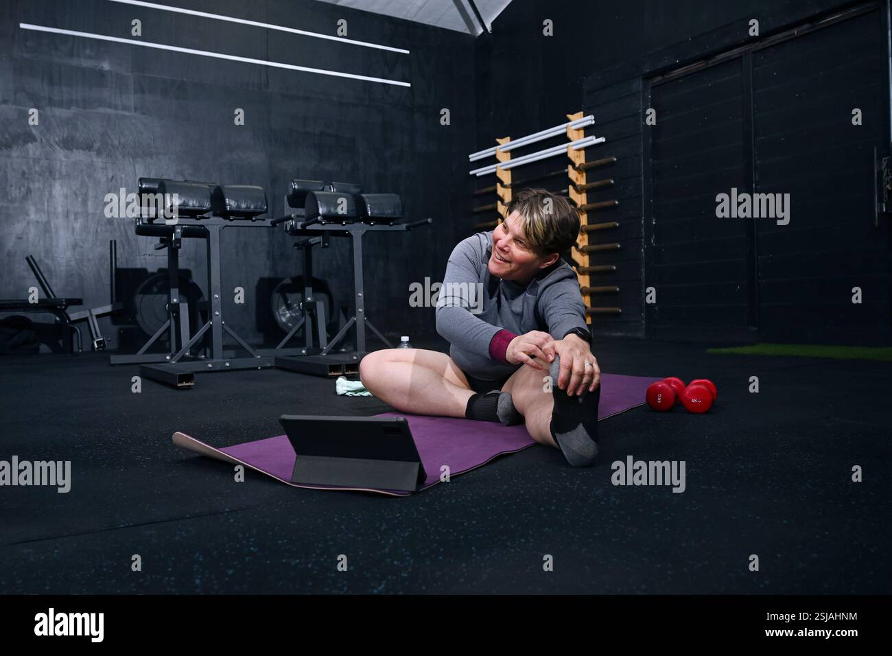 Person stretching in gym Stock Photo - Alamy