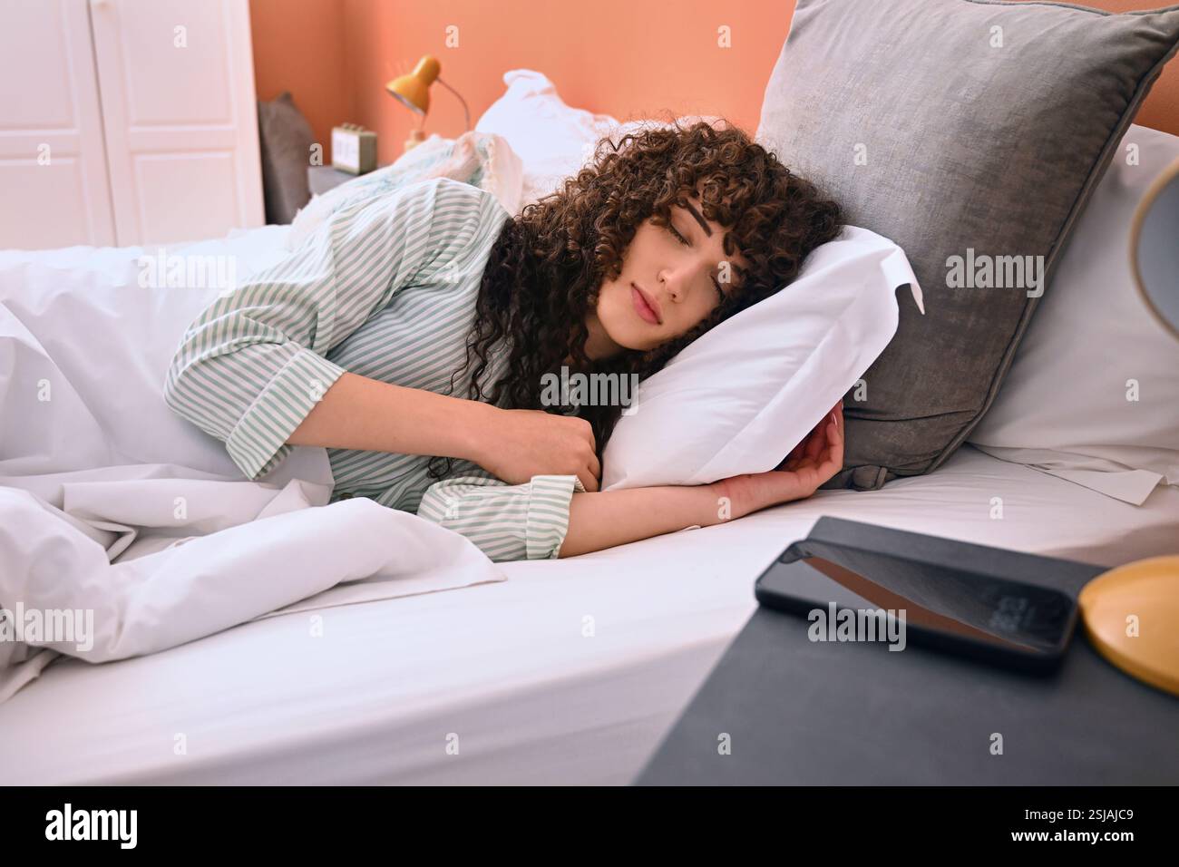 Woman sleeping in bed Stock Photo - Alamy