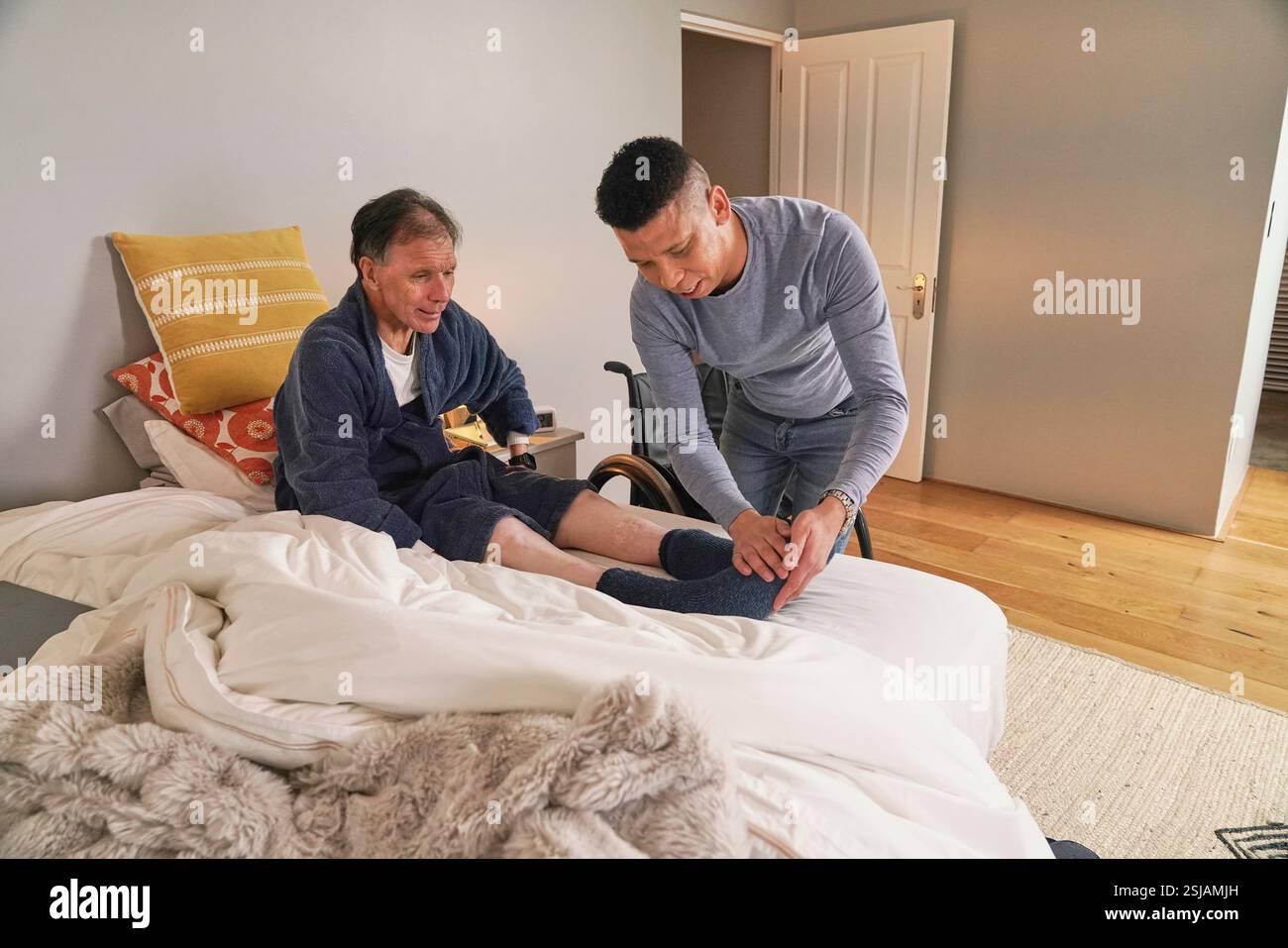 Therapist massaging disabled mans feet Stock Photo - Alamy