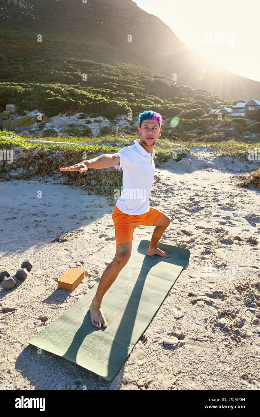 Man practicing yoga on beach Stock Photo - Alamy