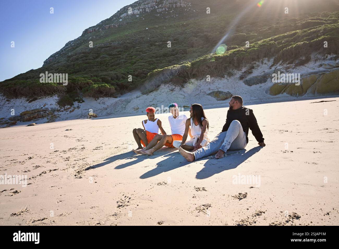 Sitting talking smiling outdoors day hi-res stock photography and ...