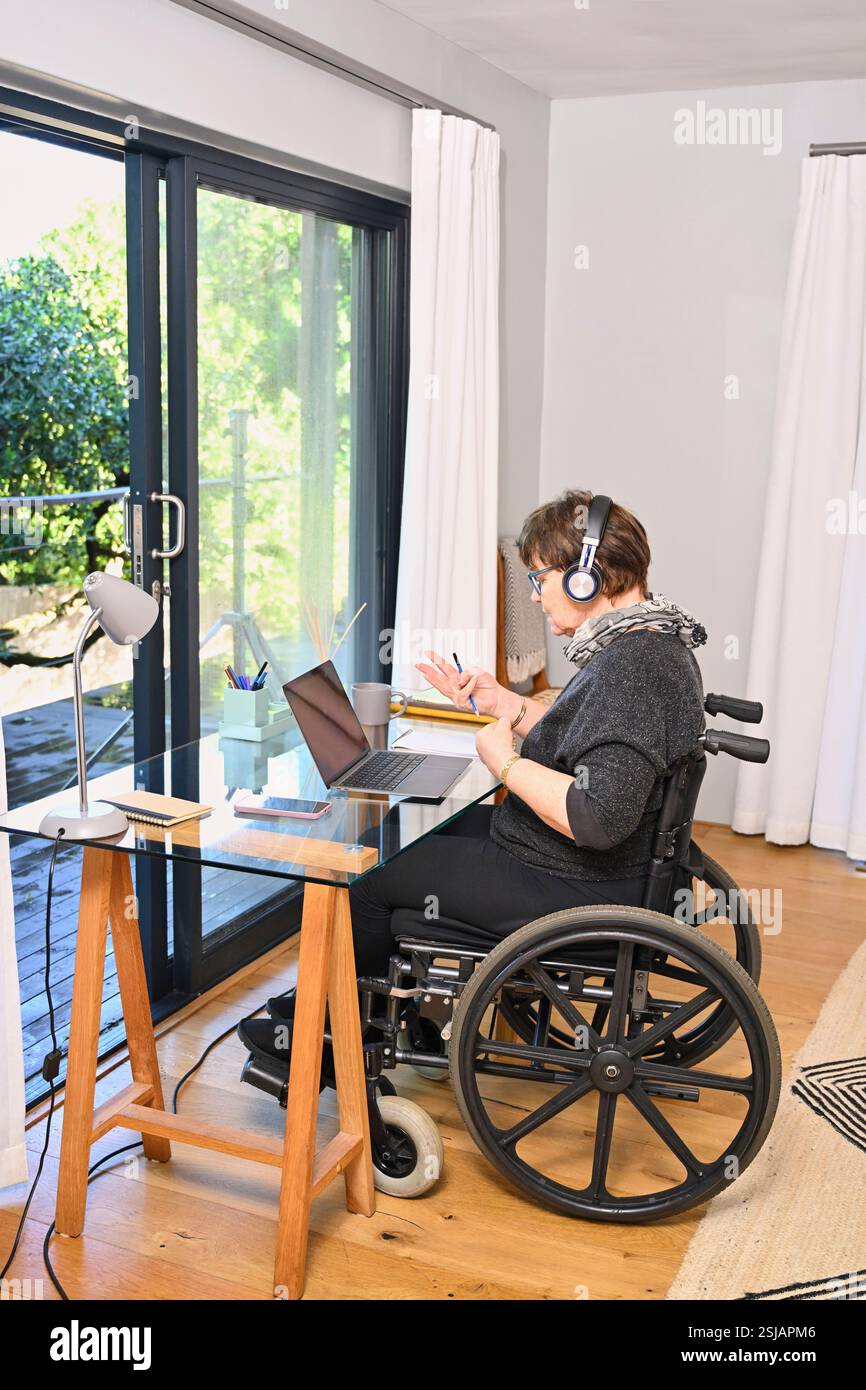 Woman in wheelchair working office hi-res stock photography and images ...