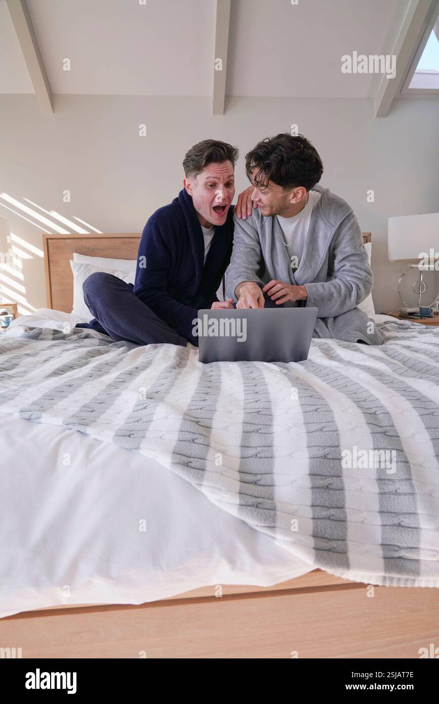 Gay man sitting on bed hi-res stock photography and images - Alamy
