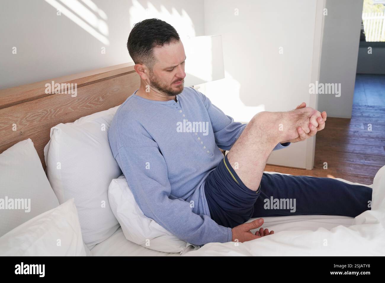 Man with amputated leg on bed Stock Photo - Alamy
