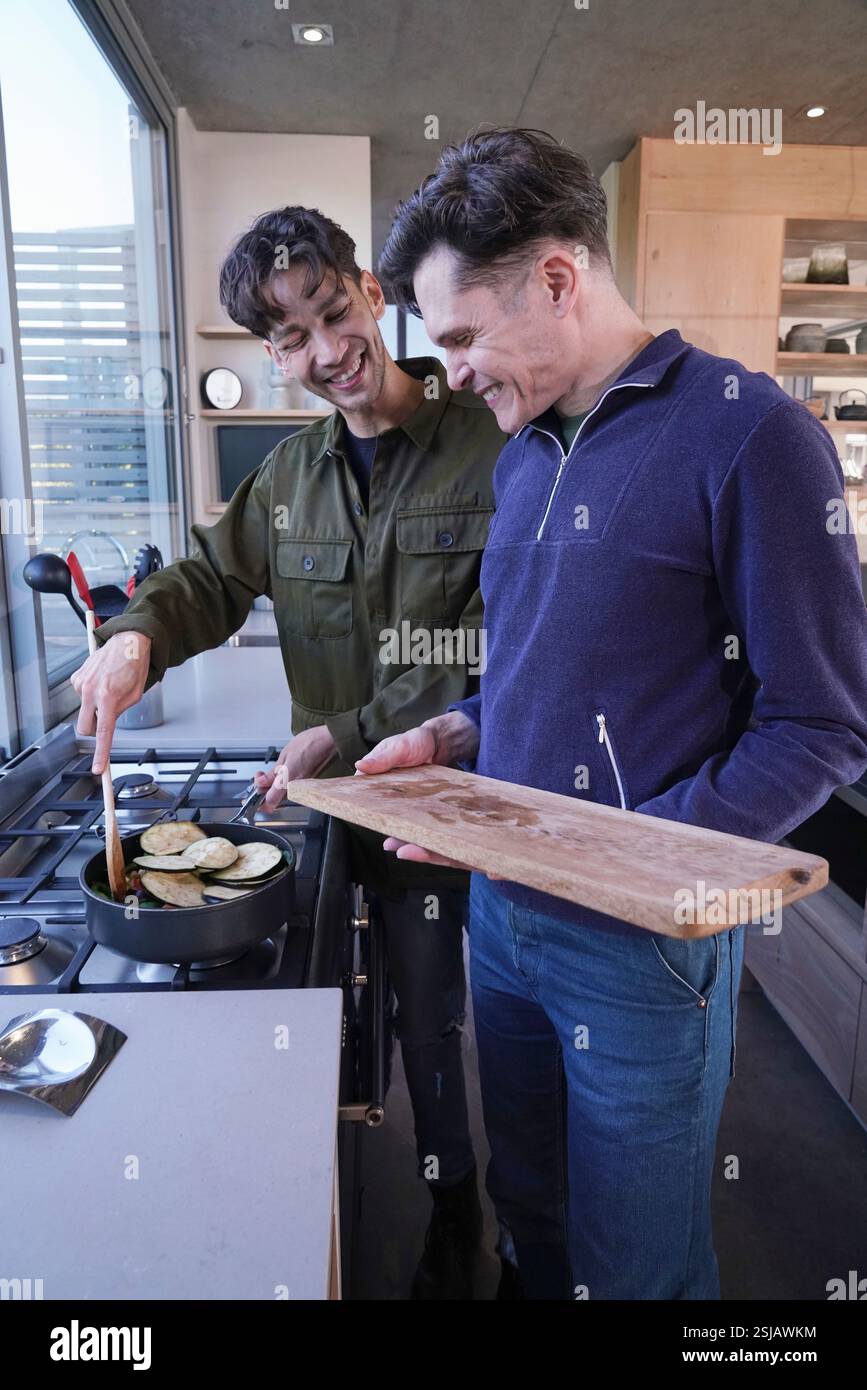 Two gay men cooking hi-res stock photography and images - Alamy
