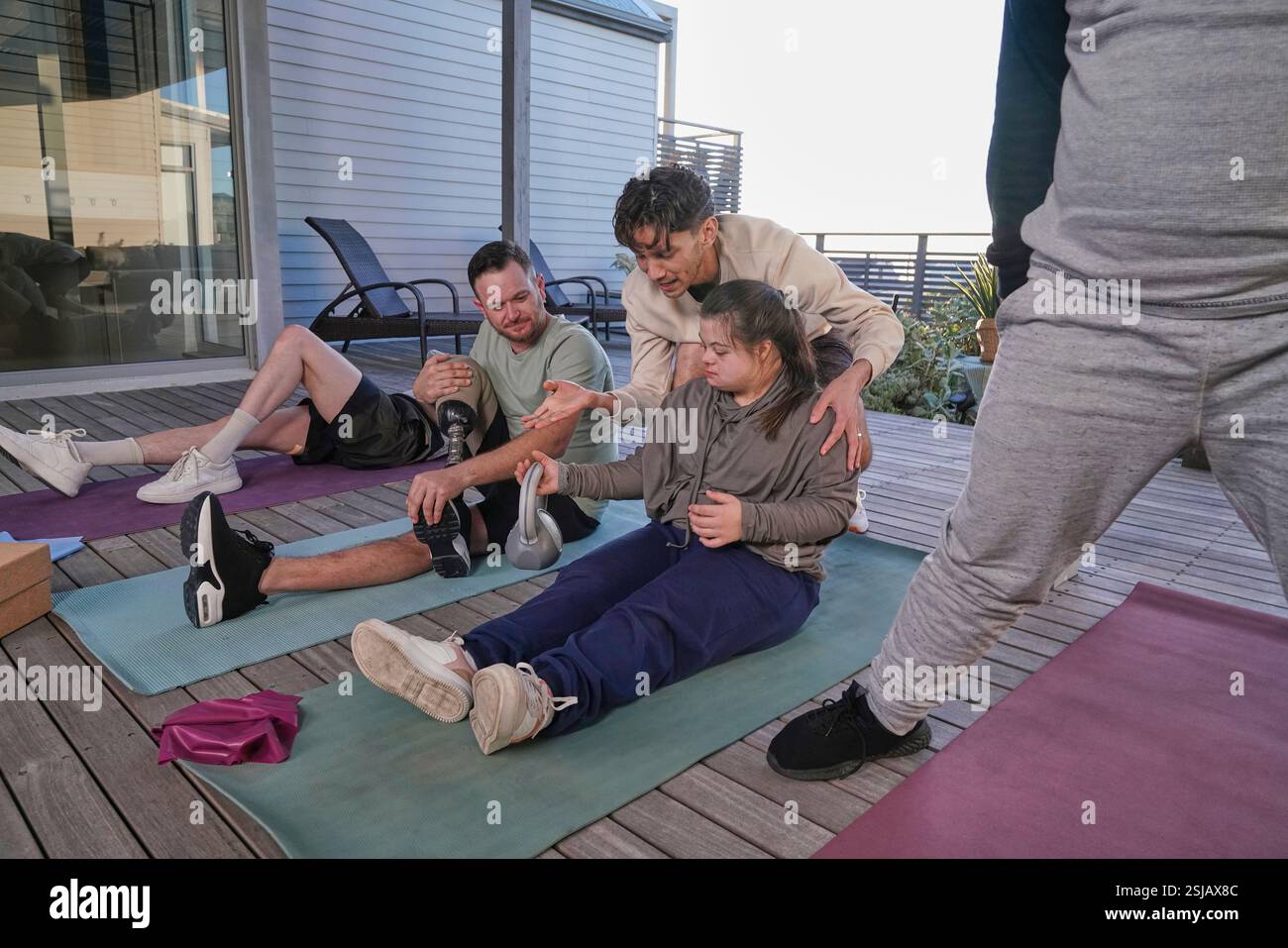 Disabled friends exercising on patio Stock Photo - Alamy