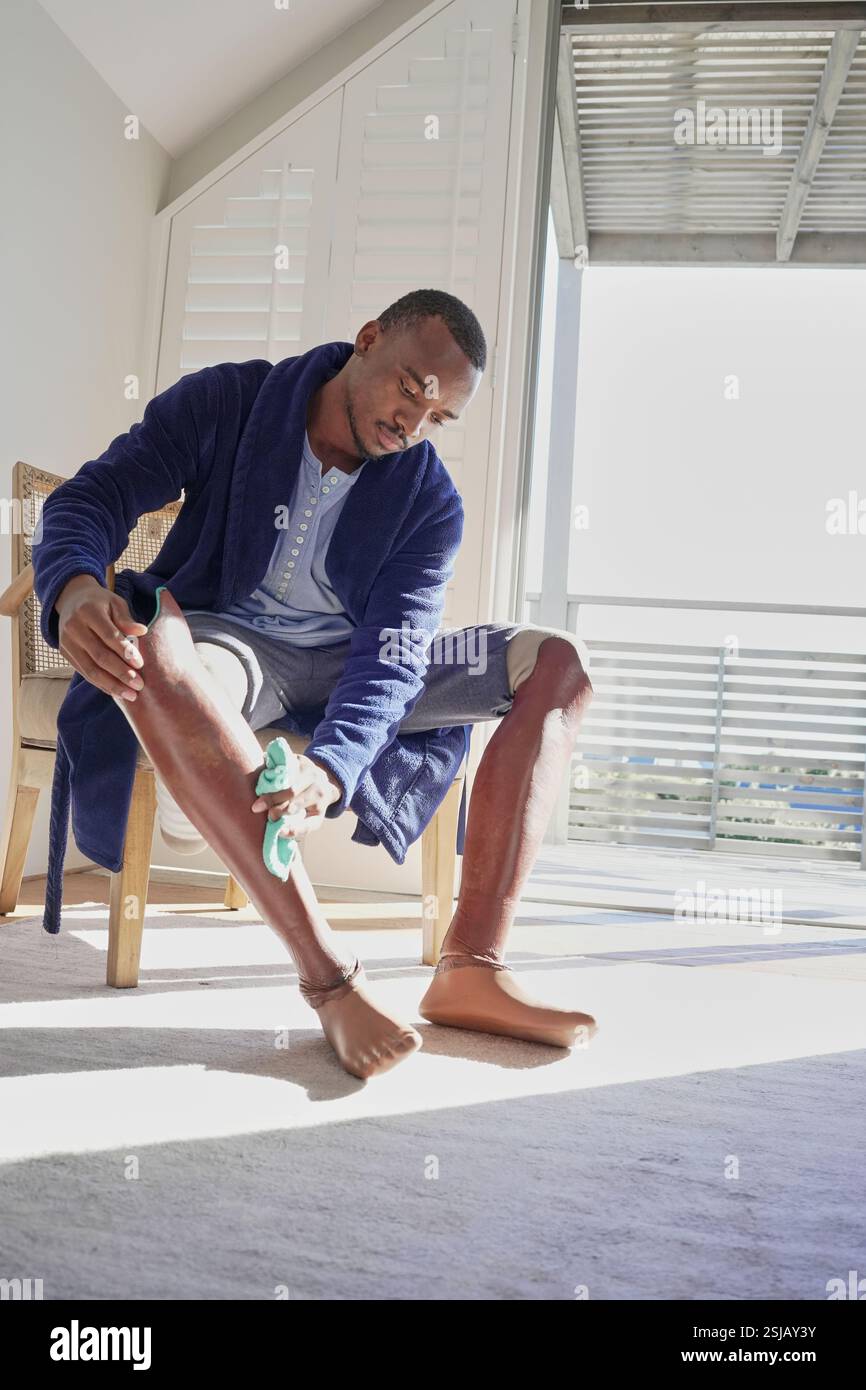 Man with leg prosthesis sitting on chair Stock Photo - Alamy