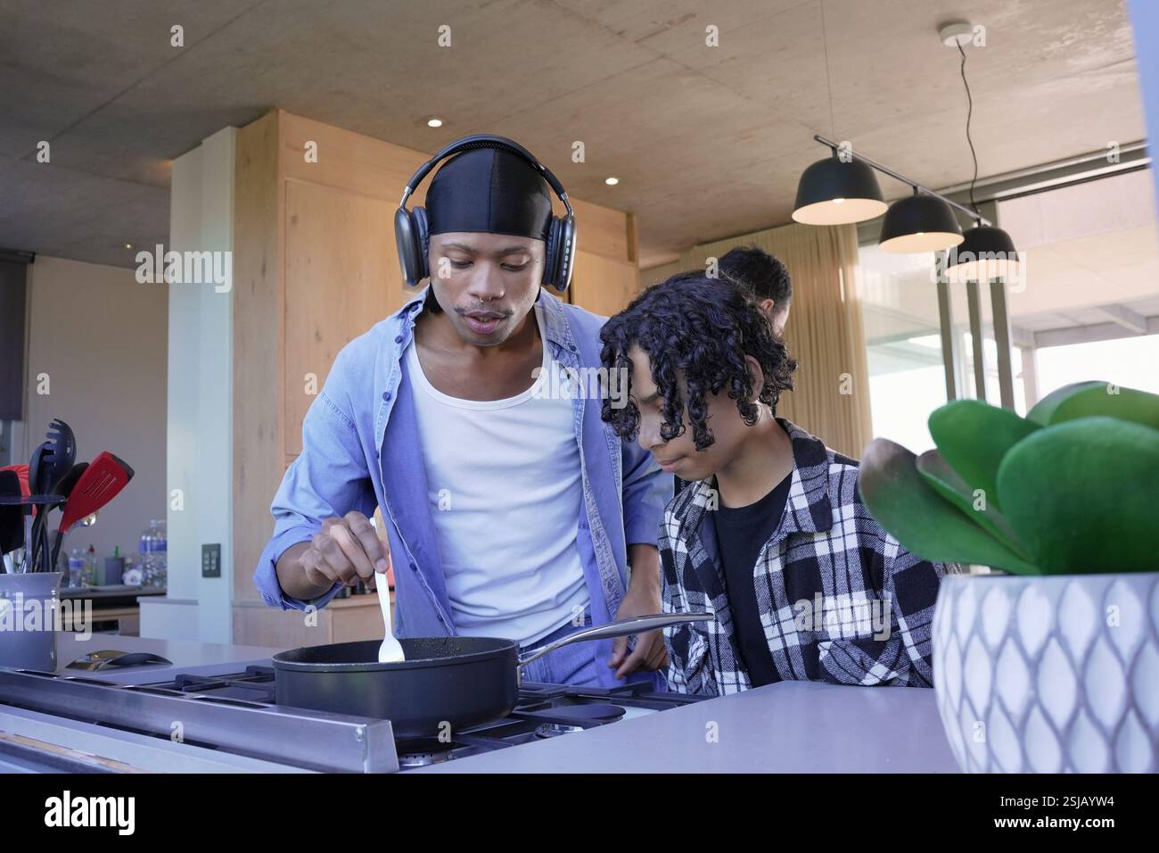 Brothers cooking together Stock Photo - Alamy