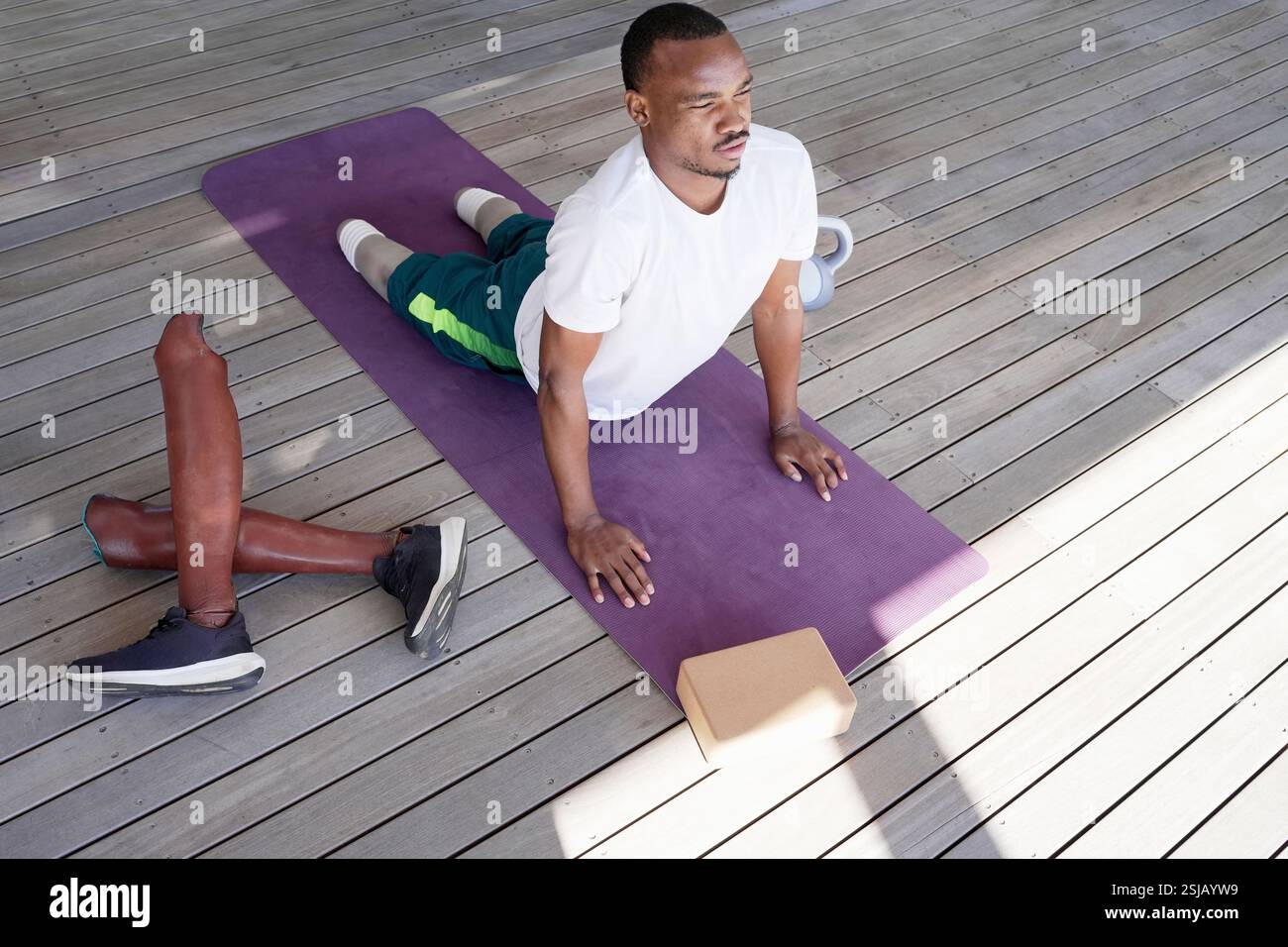 Man with amputated legs exercising on patio Stock Photo - Alamy