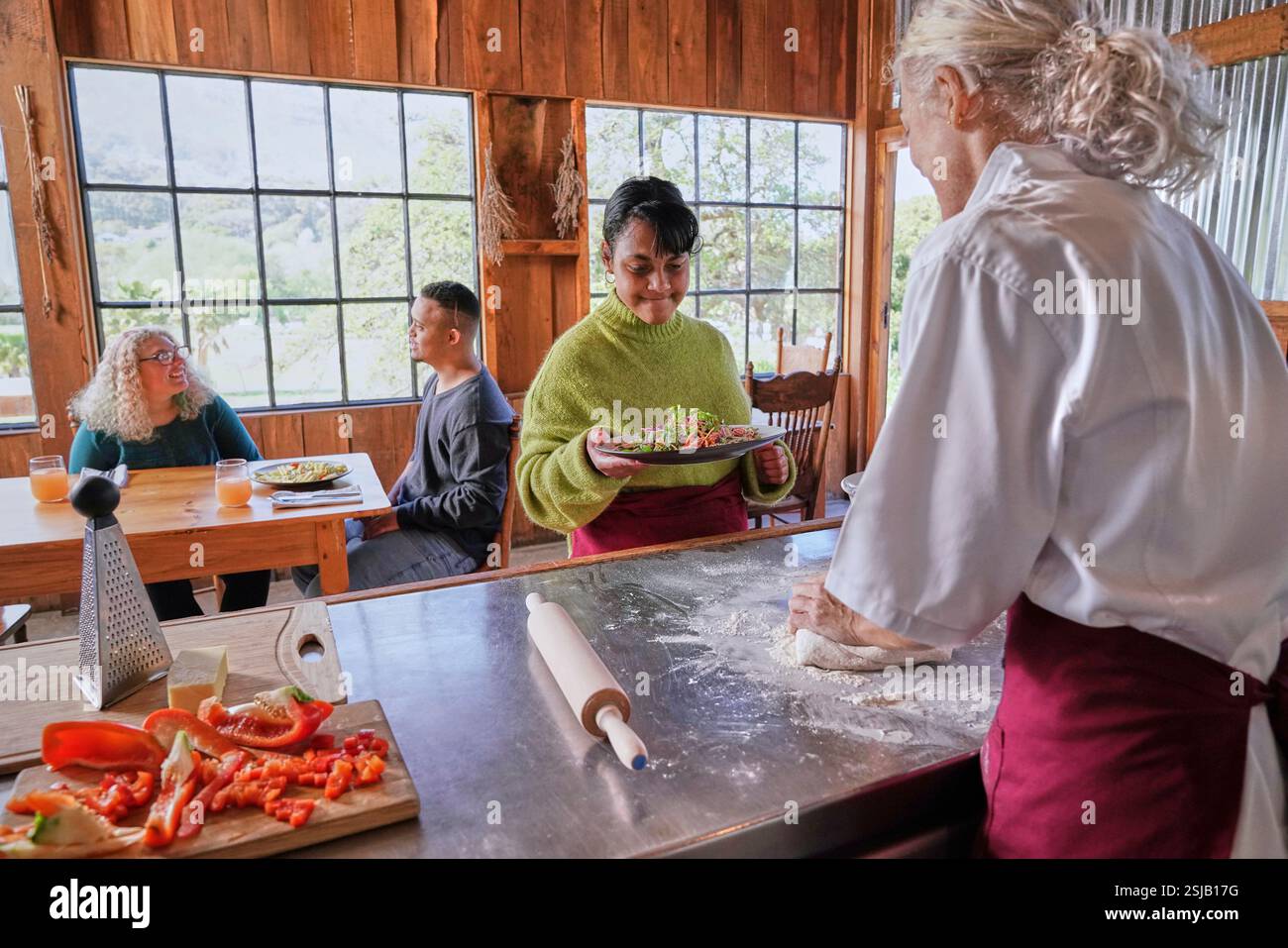Waitress taking ordered dish from counter Stock Photo - Alamy